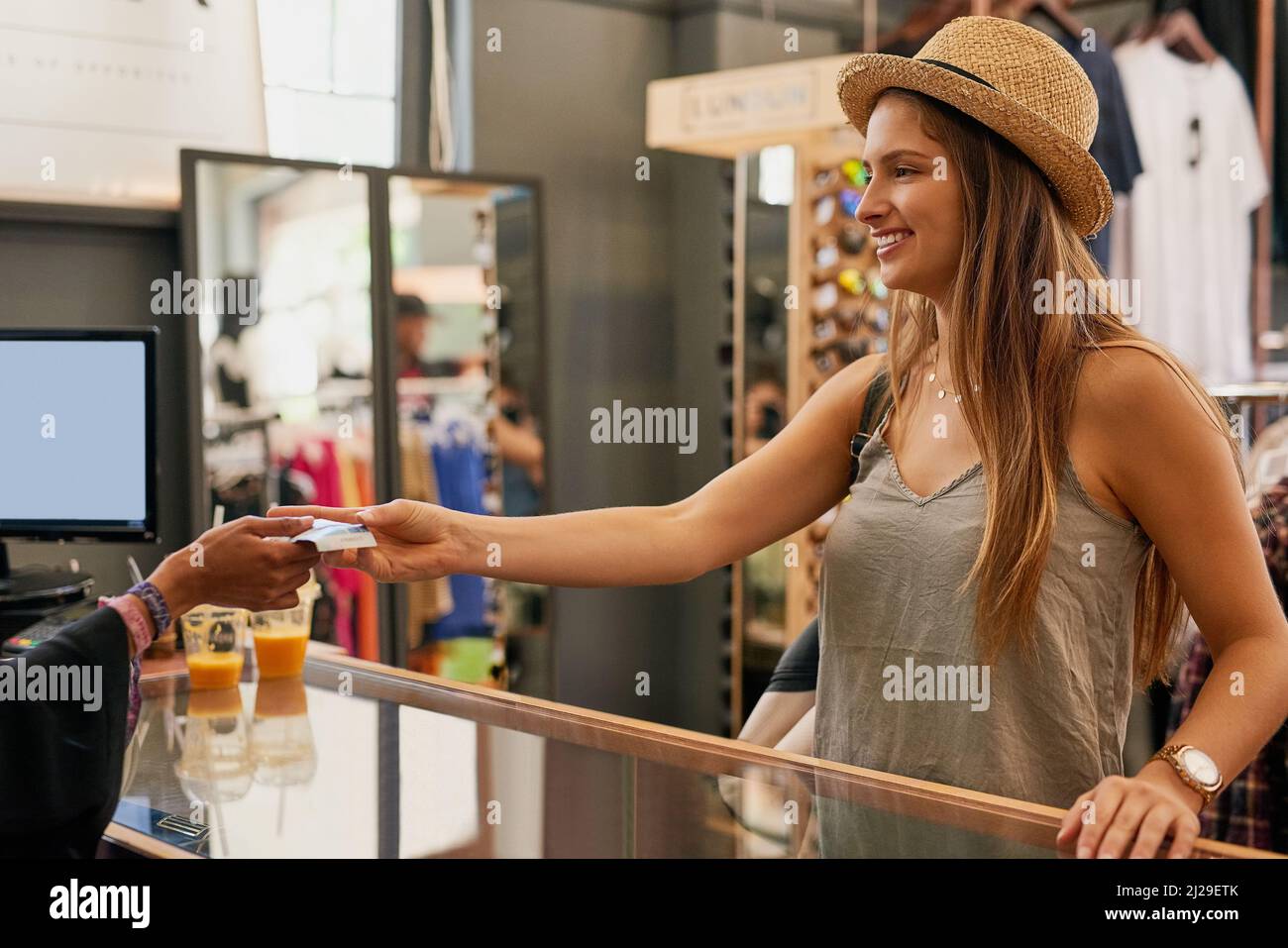 Ill be paying cash. Shot of a young woman out on a shopping spree Stock ...