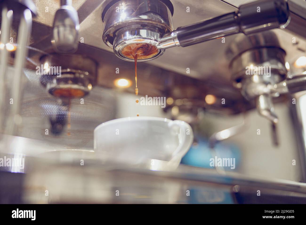 Professional coffee machine with porcelain cup in cafeteria Stock Photo ...