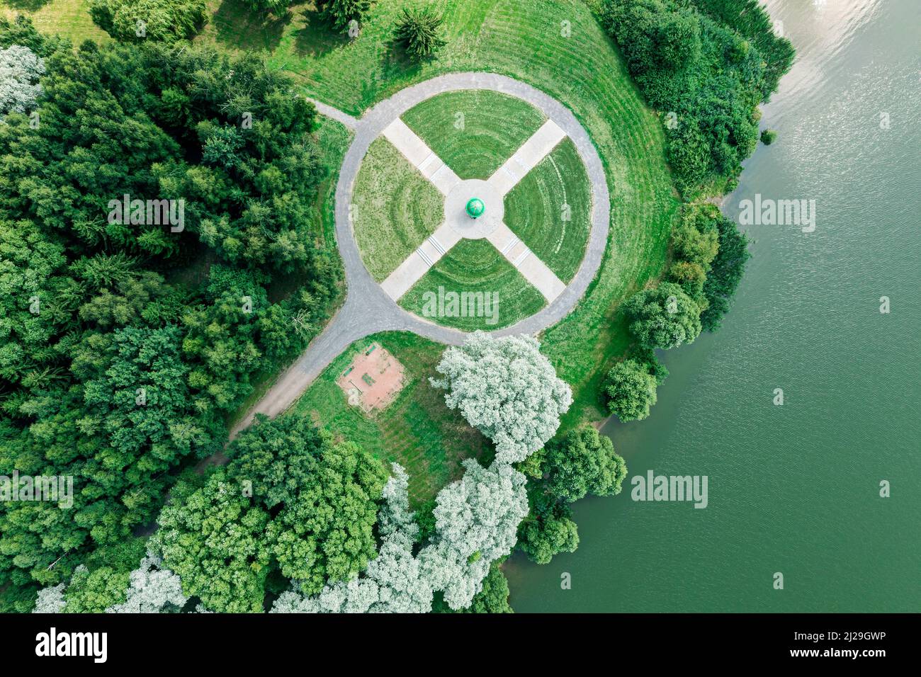 aerial top view from flying drone of a city park with walking path ...