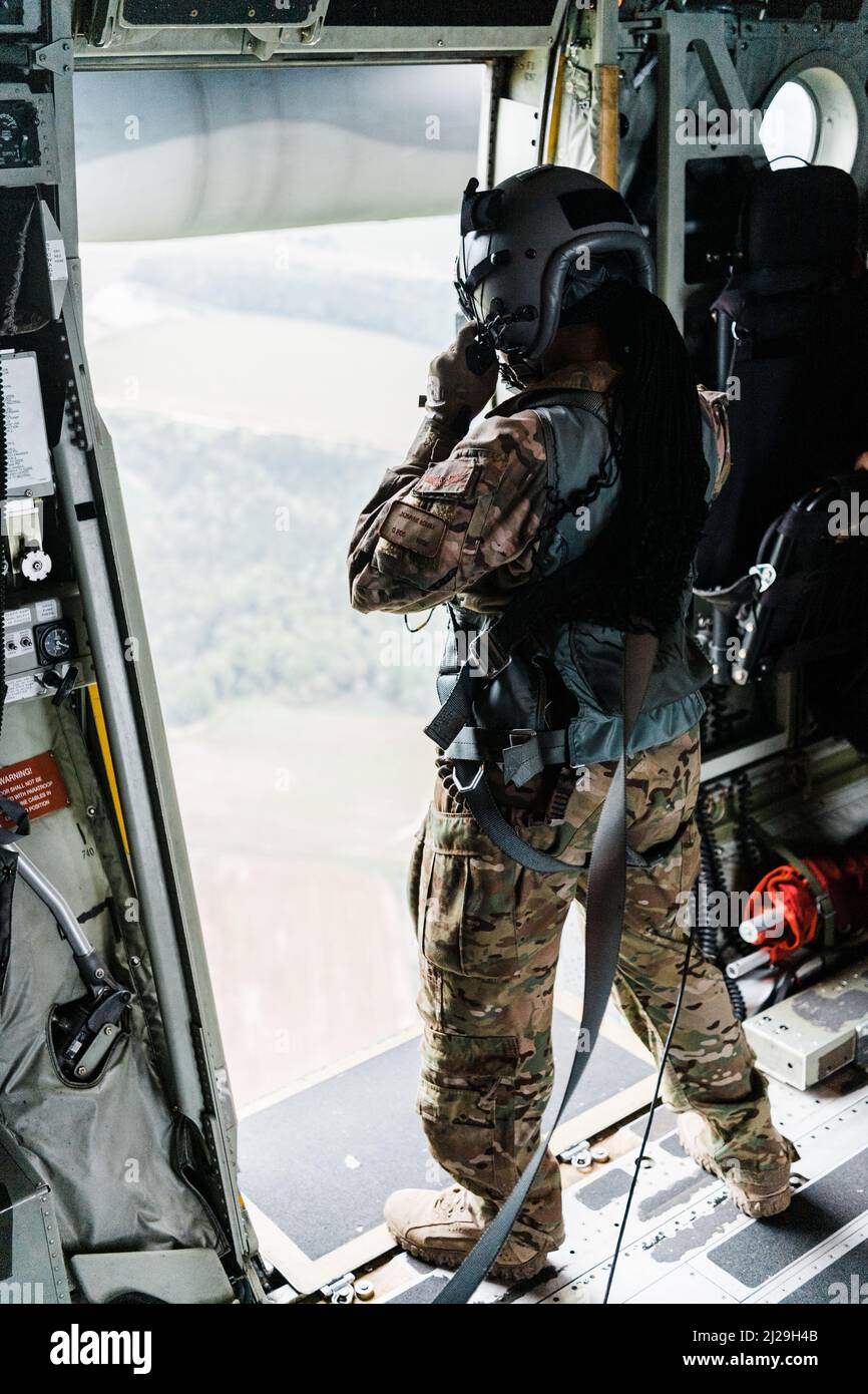 A 23d Wing HC-130 Combat King II Rescue Loadmaster conducts door bundle ...