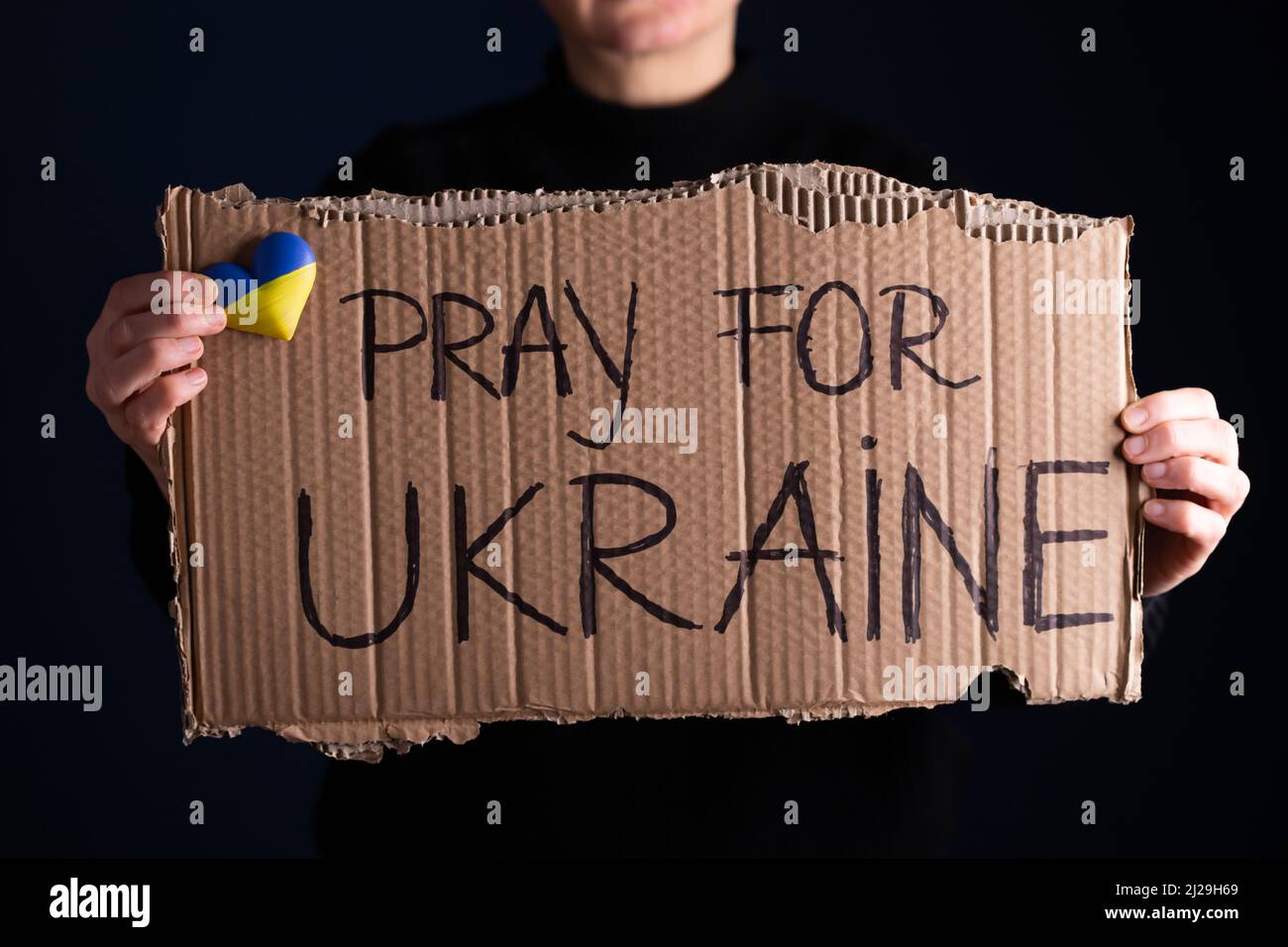 Woman holds a banner with anti-war message. Protest against the Russian ...