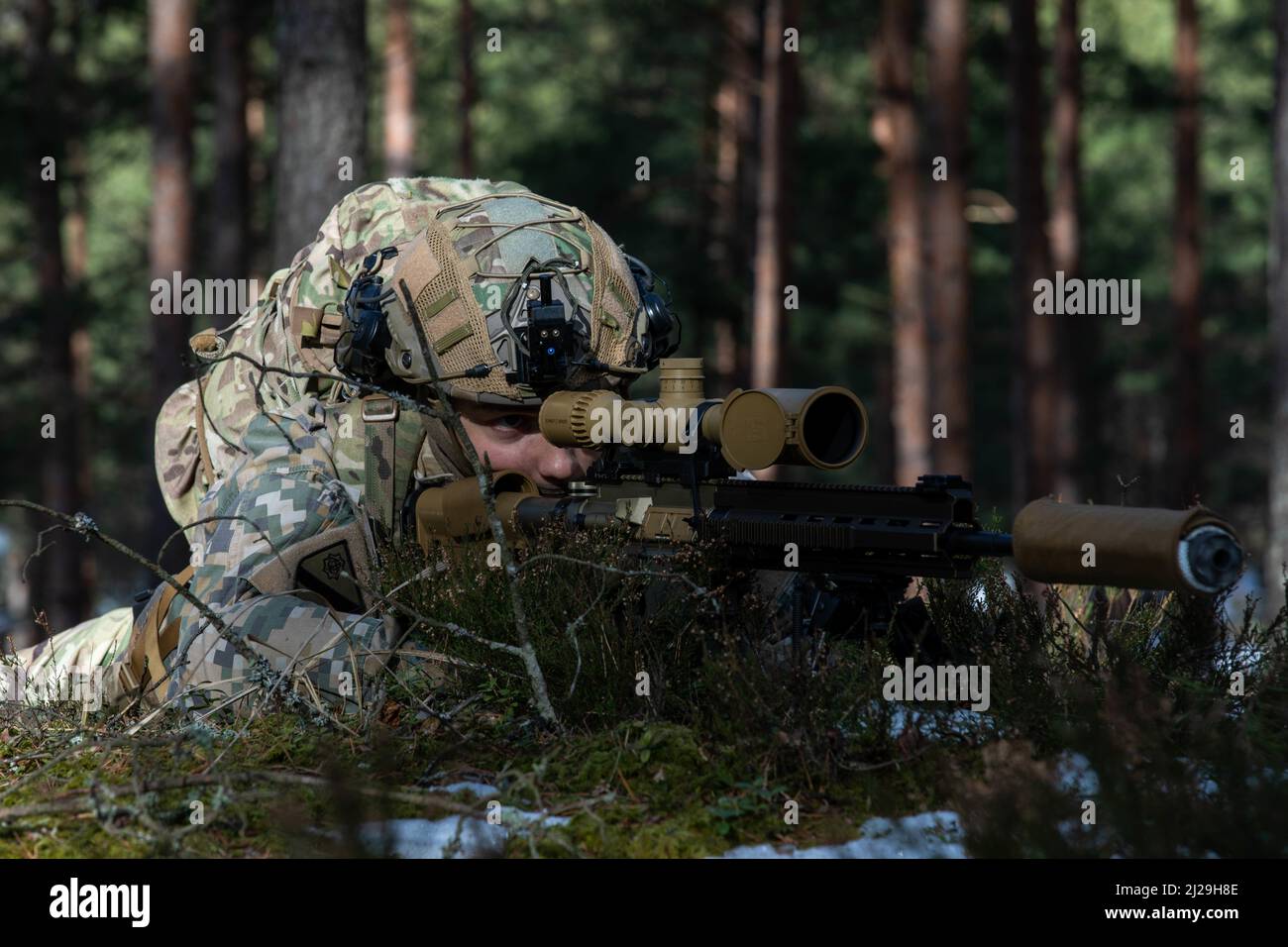 20220303-A-VU095-1049 – A Latvian National Guard soldier assumes an ...