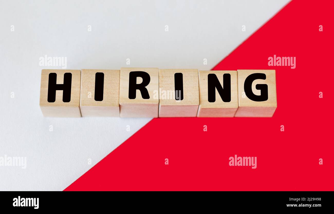 HIRE word made from building blocks on red and white background Stock ...