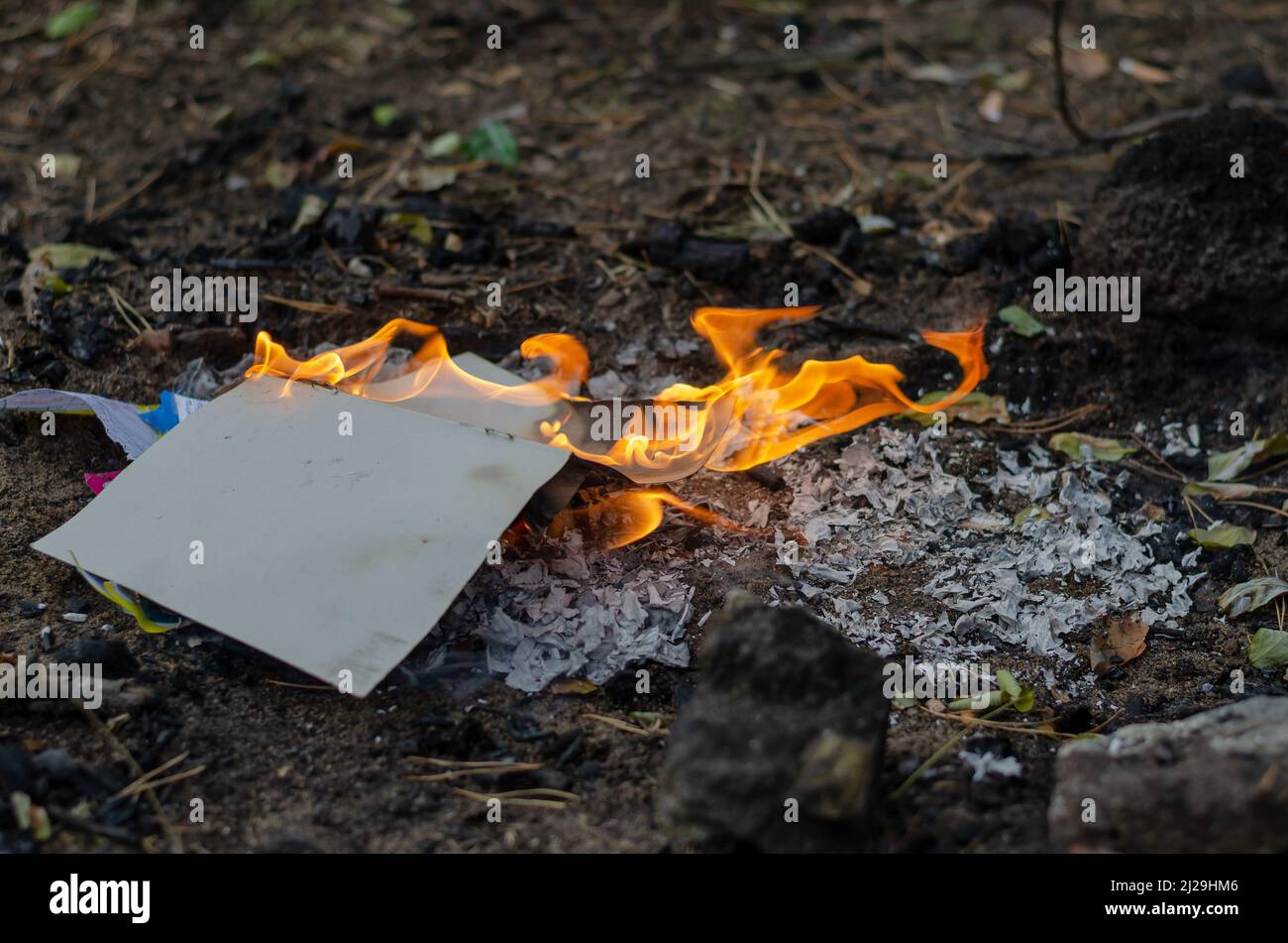 Burning in the fire of a torn notebook. The cover and the multi-colored ...