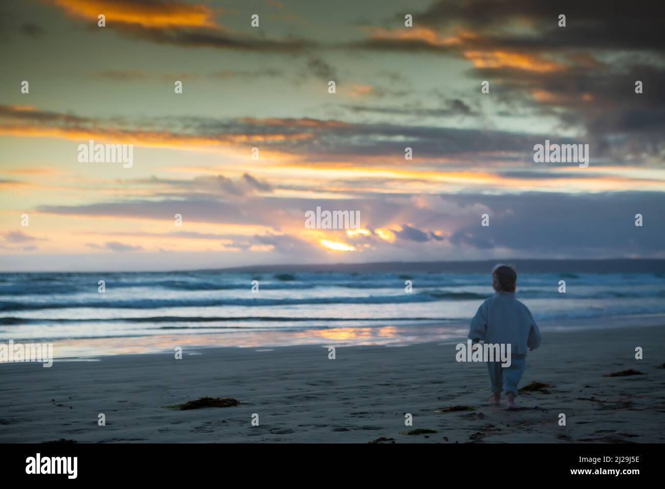 Child on a beach Stock Photo - Alamy