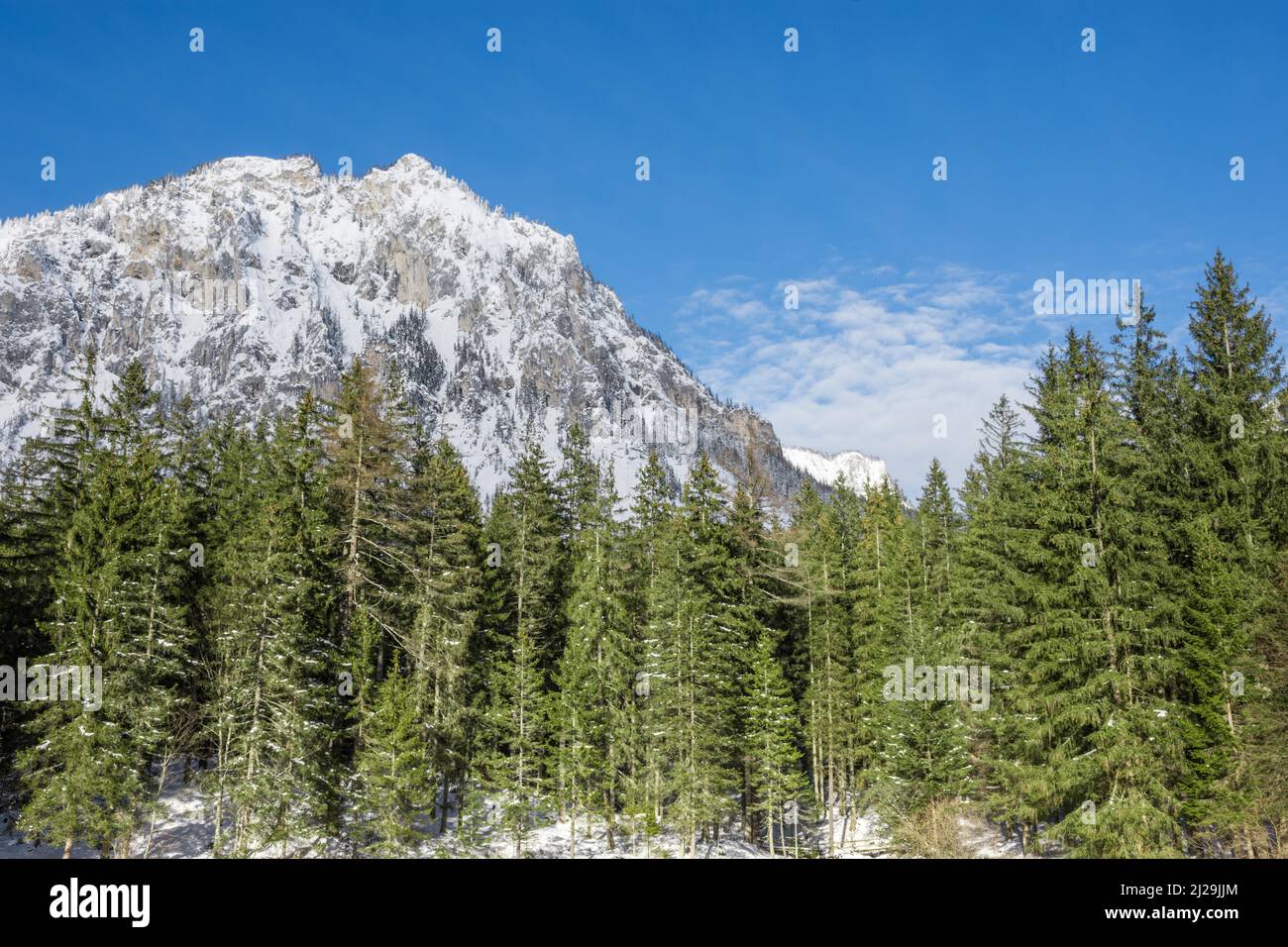 Green lake (Grunner see) and mountain in sunny winter day. Famous ...