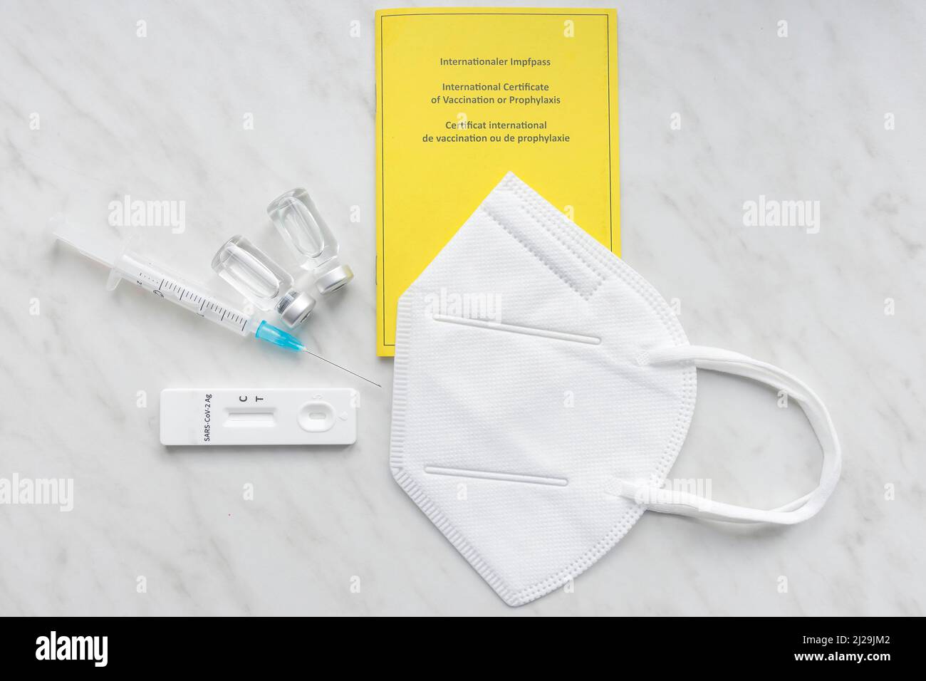 Medical mask, antigen test, vaccination certificate, vaccine bottles ...