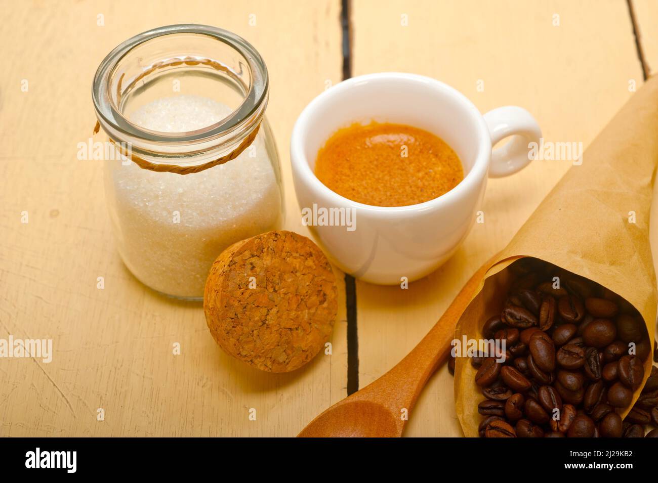 Espresso coffee and beans on a paper cone cornucopia over white ...