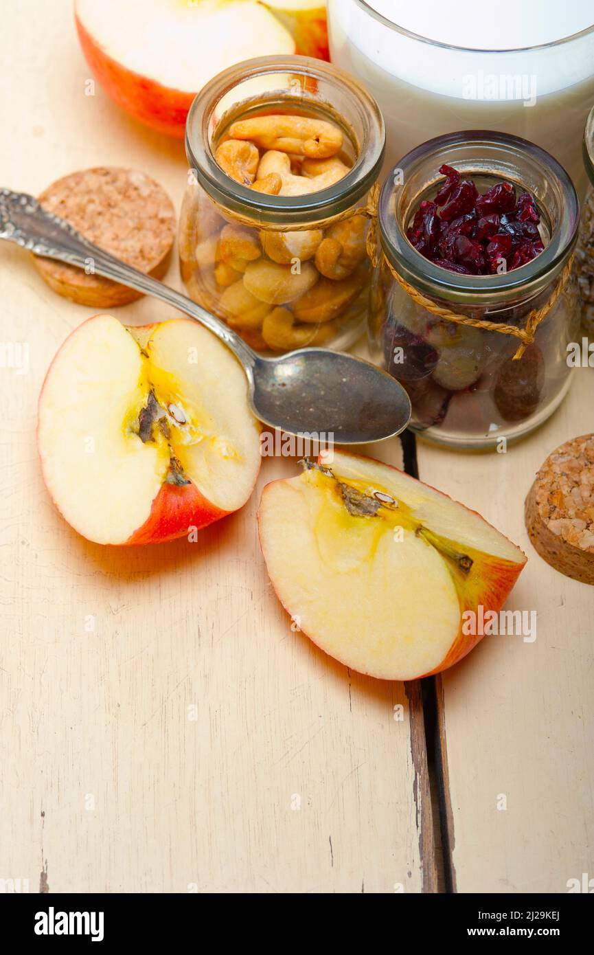 Healthy breakfast ingredients milk oat cashew nuts dried cramberry ...