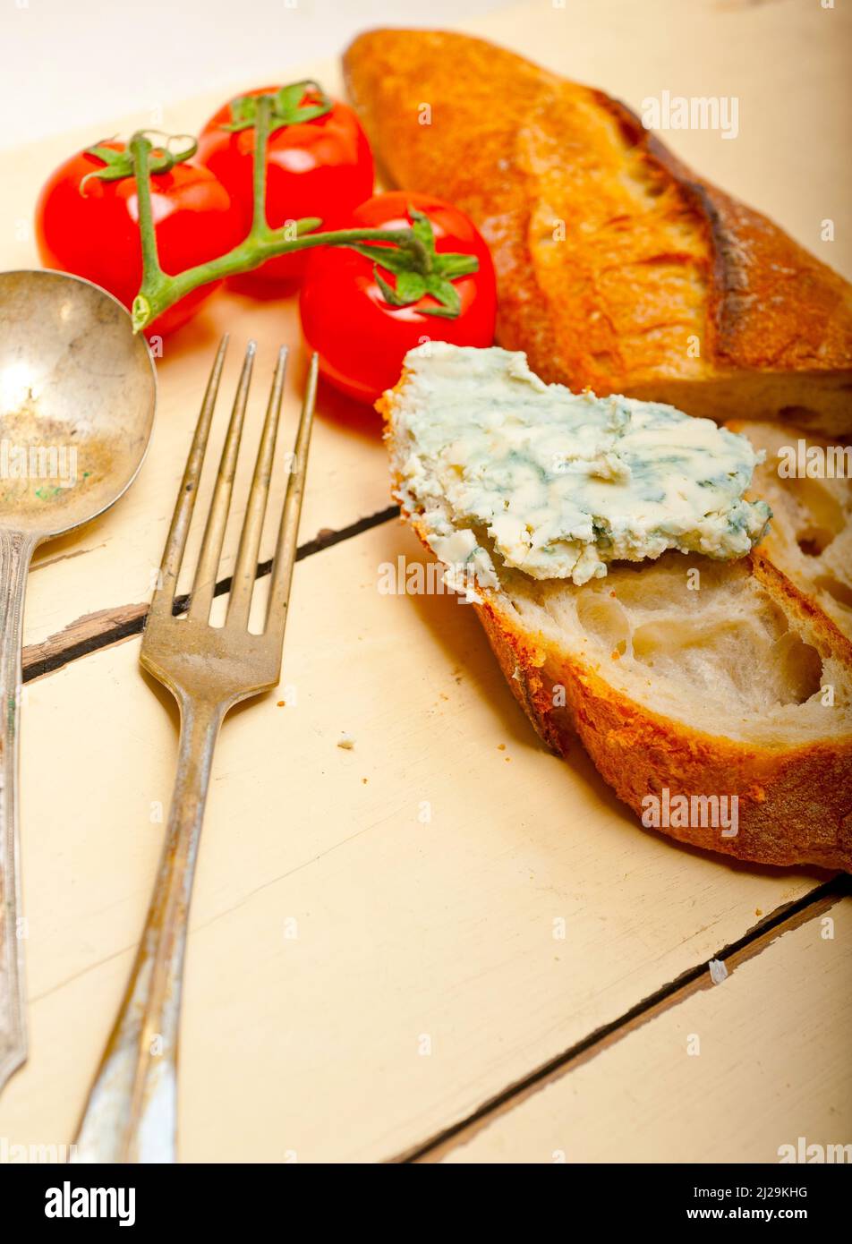 Fresh blue cheese spread ove french baguette with cherry tomatoes on ...