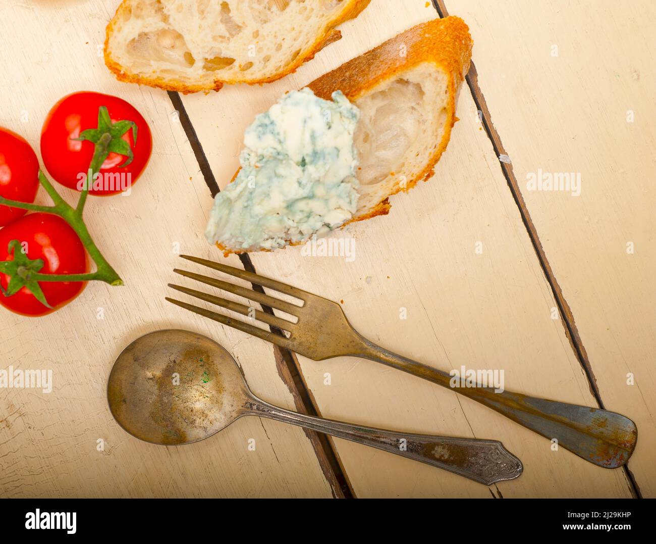 Fresh blue cheese spread ove french baguette with cherry tomatoes on ...