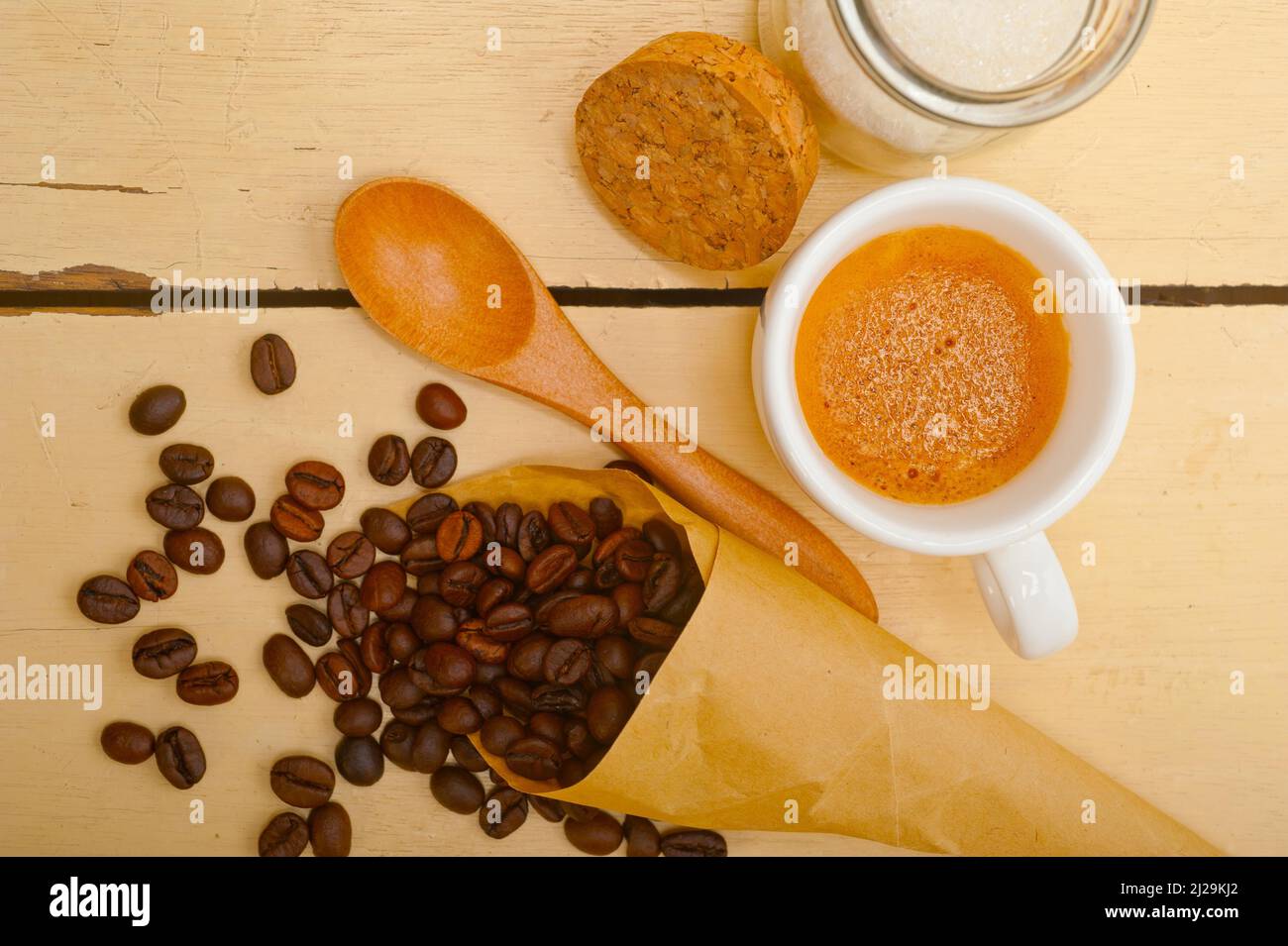 Espresso coffee and beans on a paper cone cornucopia over white ...