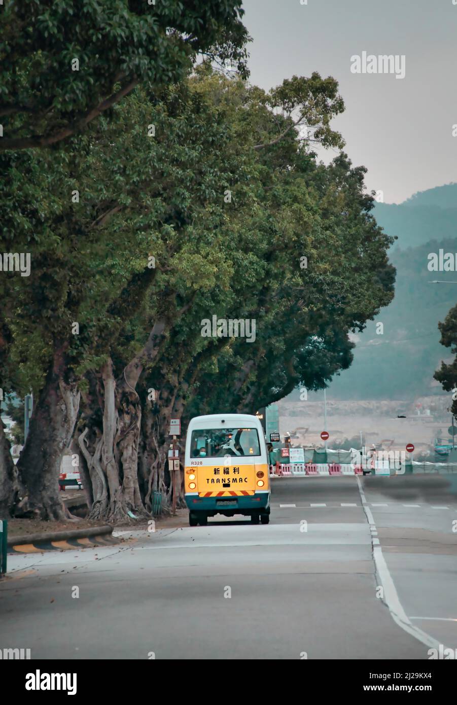 Yellow bus on the street in Macau, China Stock Photo - Alamy