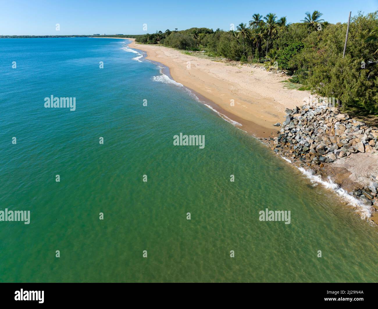 Drone aerial landscape of a long stretch of coastal sandy beach with ...