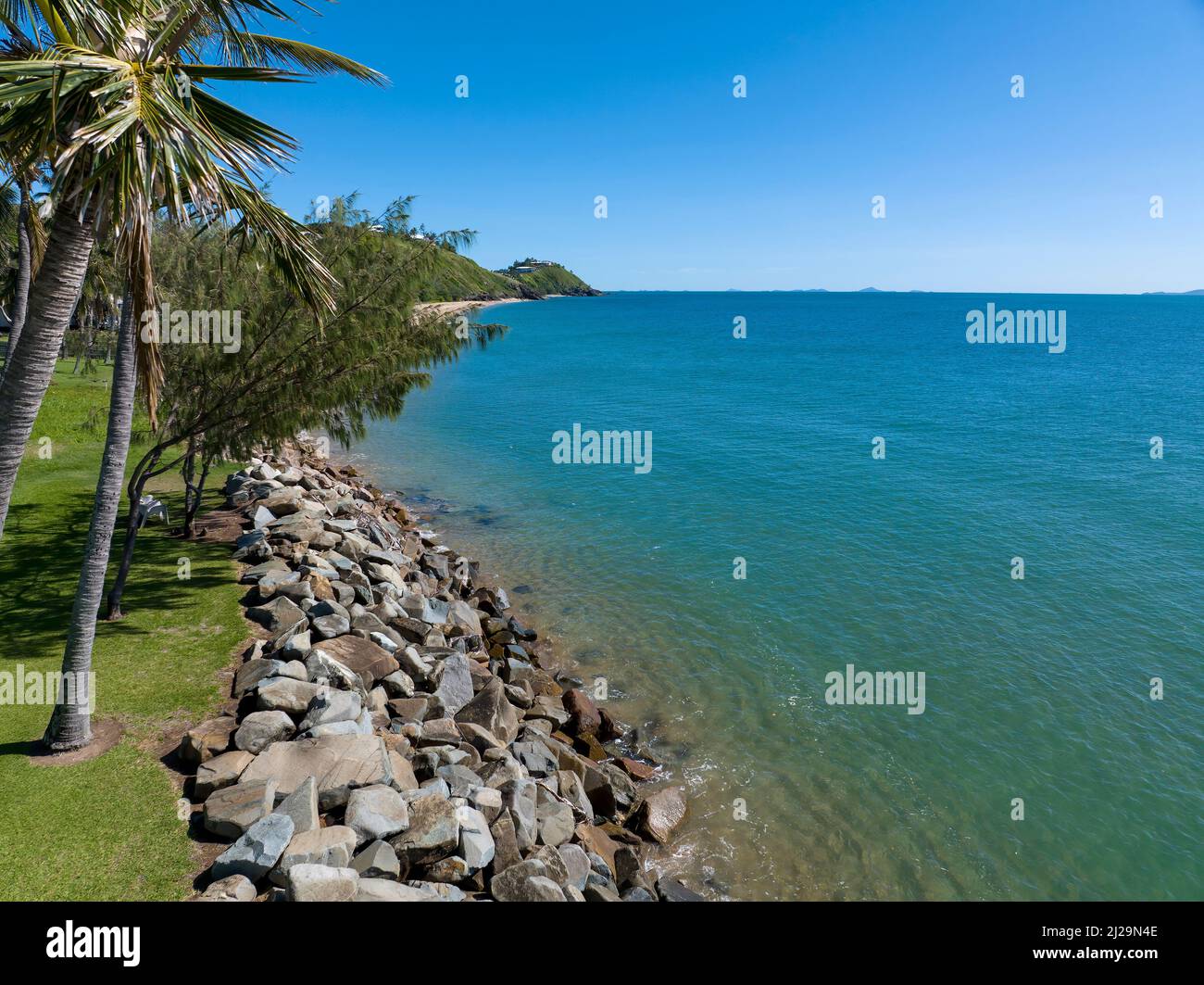 A rock retaining wall holding back the ocean in front of a coastal ...