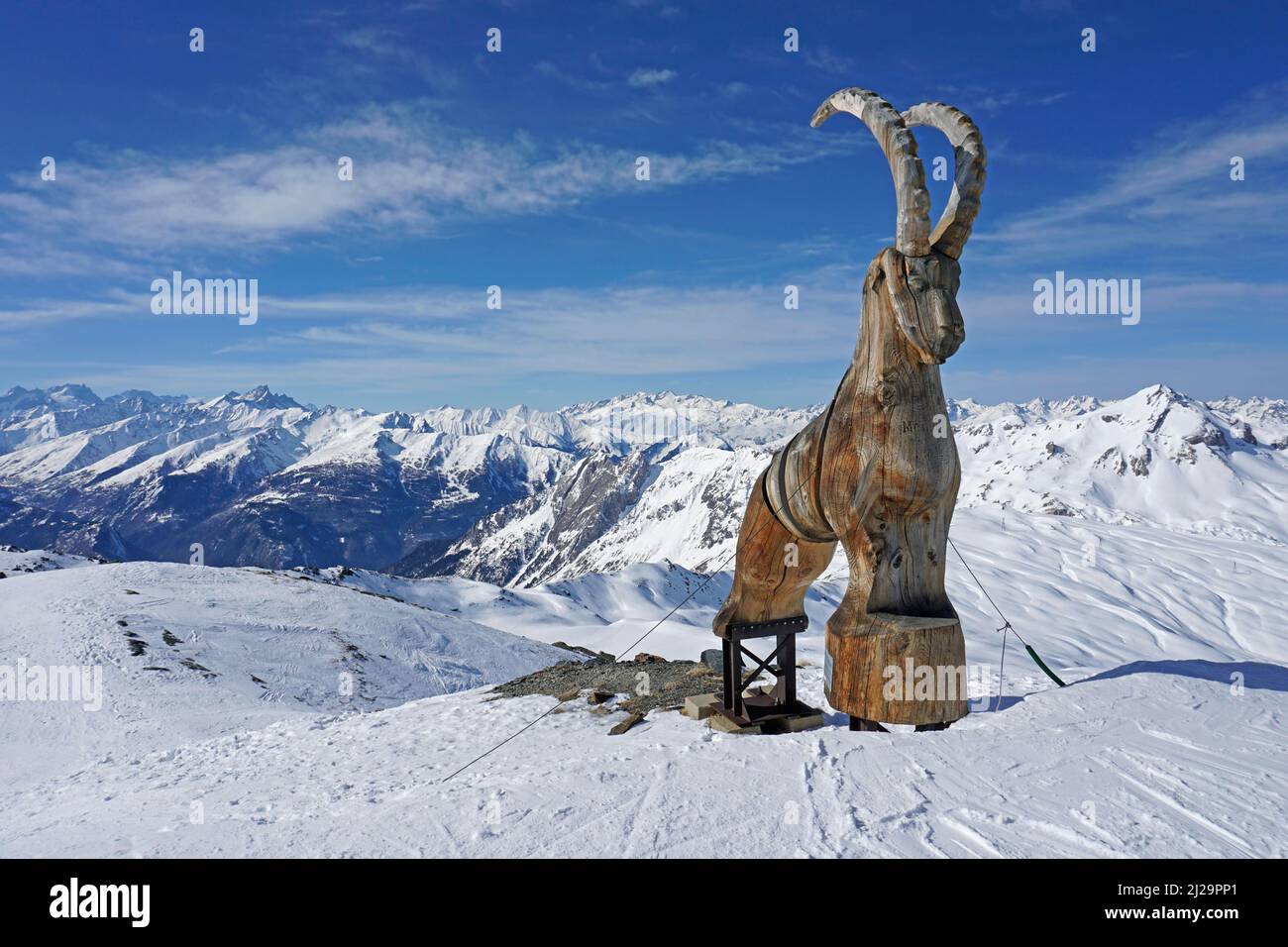 Wooden ibex figure, work of art, snow-capped mountains, La Masse peak ...