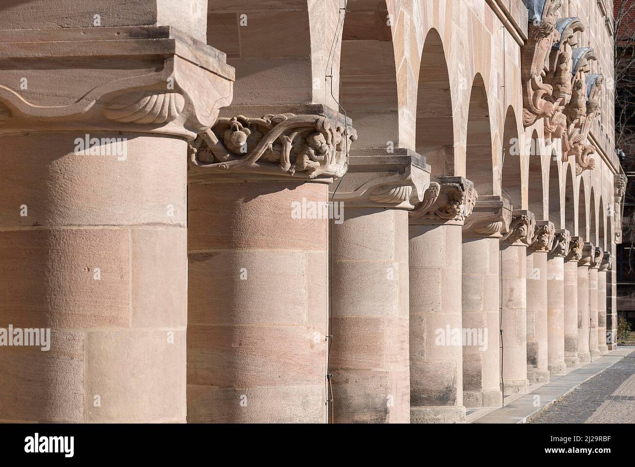 Round columns with ornate capitals of the arcade of the courthouse ...