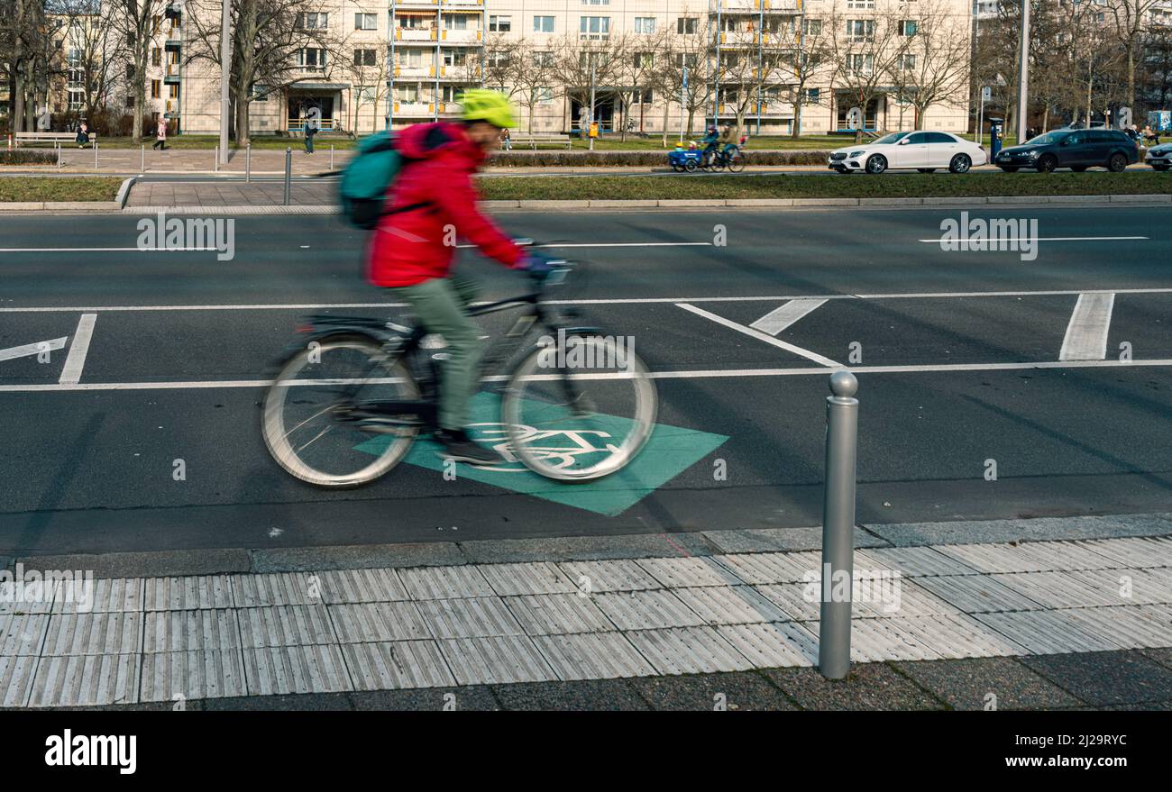 Cyclists on the wide cycle path in Karl-Marx-Allee, Berlin, Germany ...