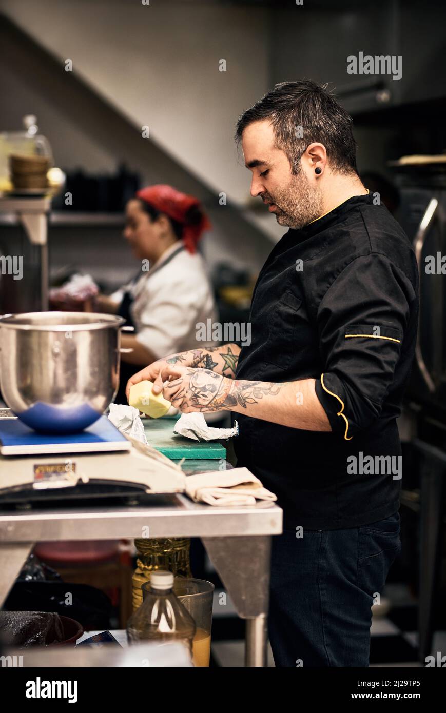 Allright lets get to work guys. Shot of a focused chef preparing a dish ...
