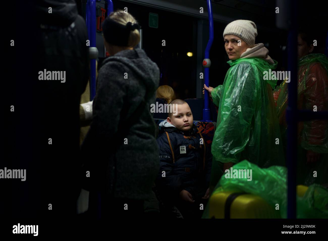 A young Ukrainian refugee sits on a bus bound for Przemysl after ...