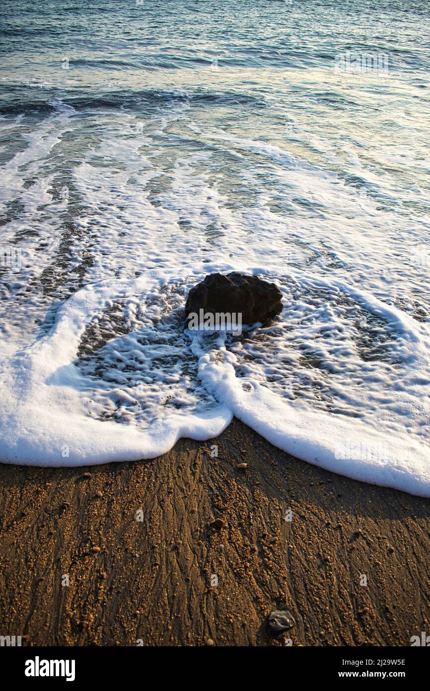 The beautiful waves splashing on a rock Stock Photo - Alamy