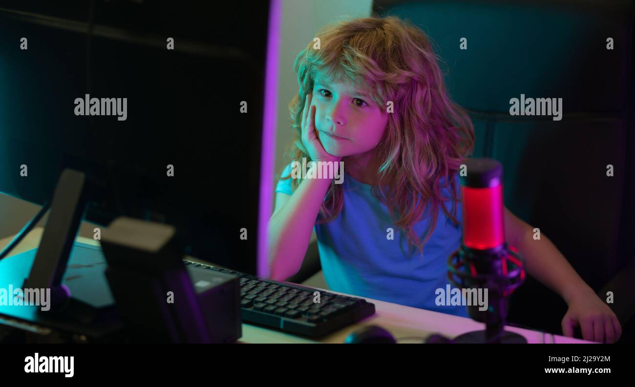Child with computer late at night. Social media for kids. Neon blue ...