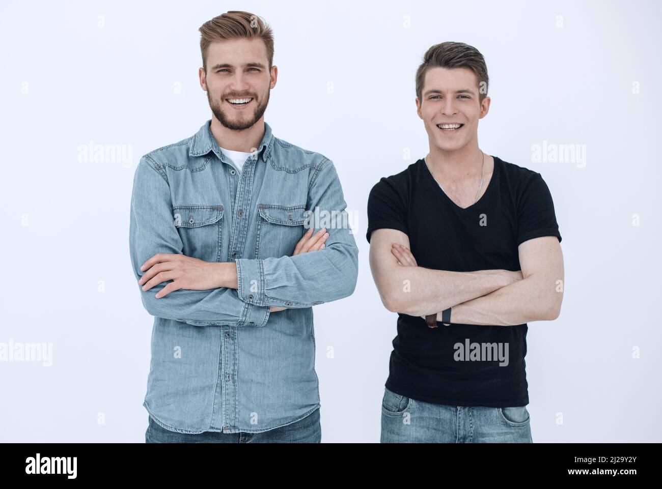 A full-length shot of two friends standing Stock Photo - Alamy