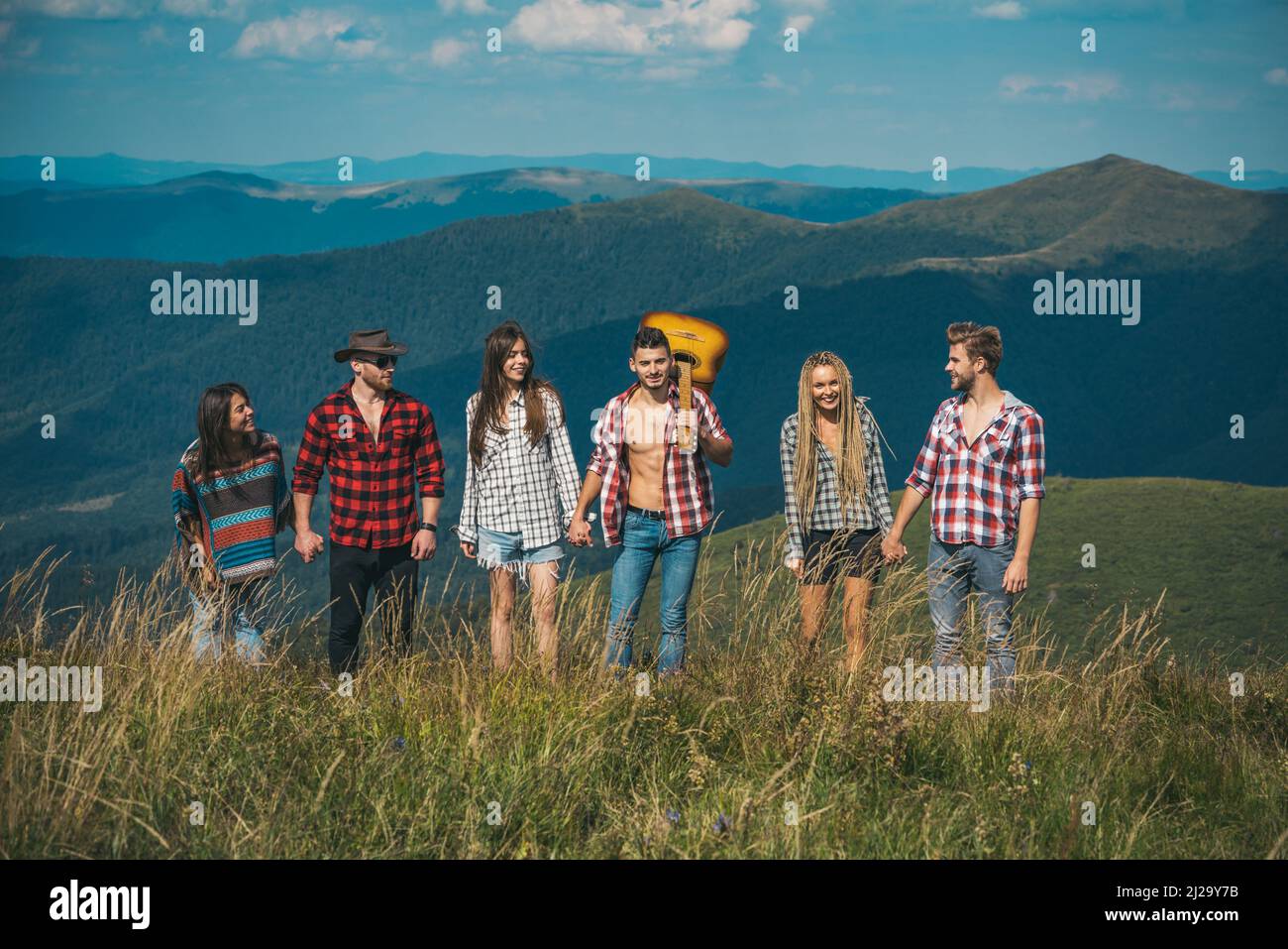 Group of friends on country walk on a summer day. Young people hiking ...