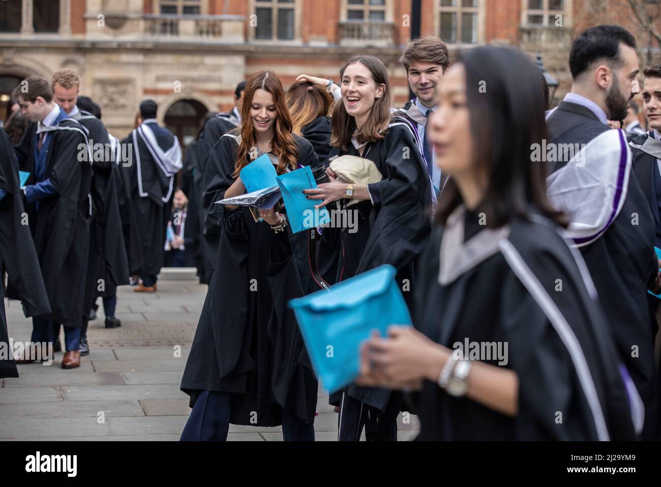Imperial College London graduates enjoy the atmosphere outside the ...