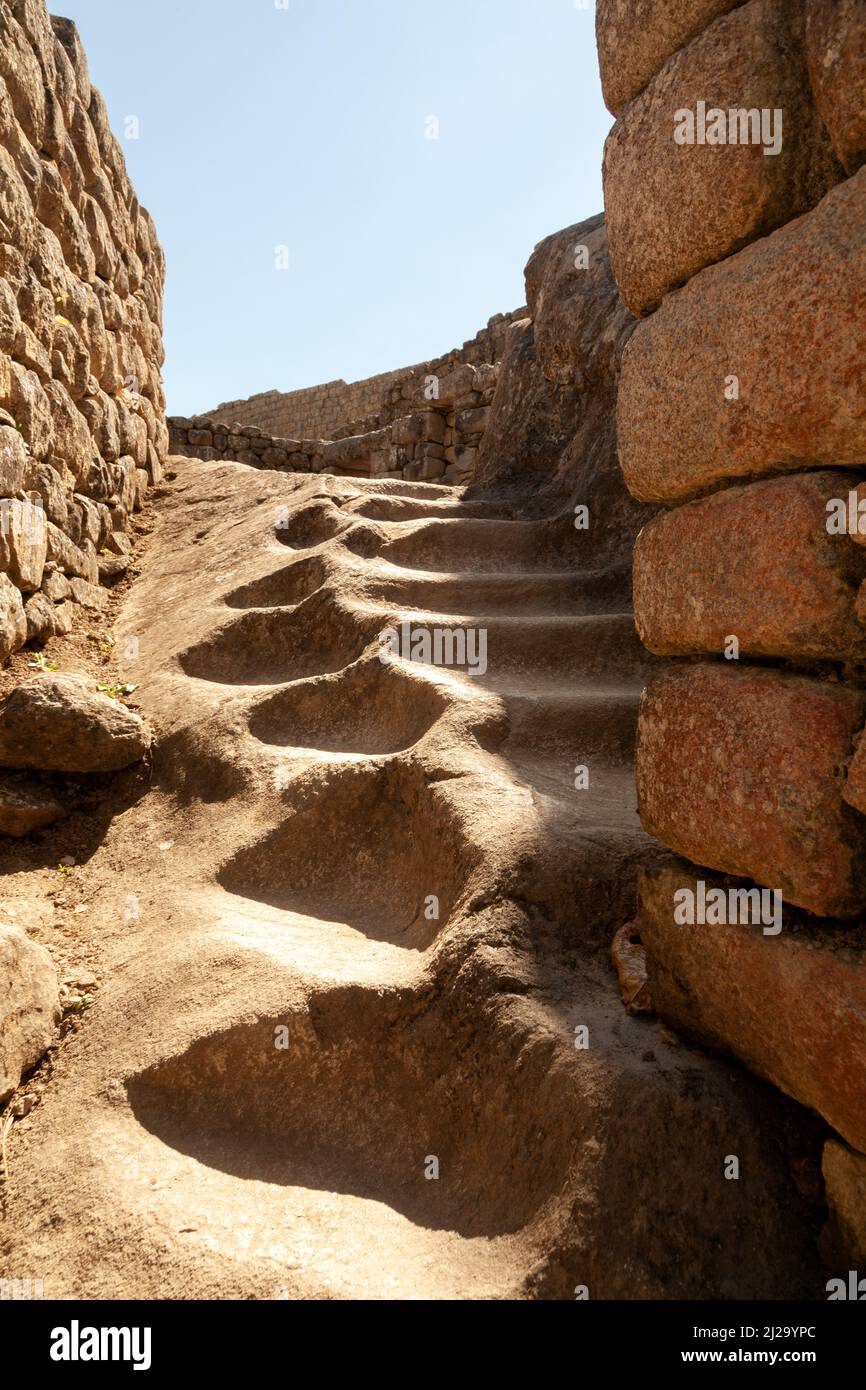 A beautiful shot of old stone walls and ancient rocky stairs ground in ...