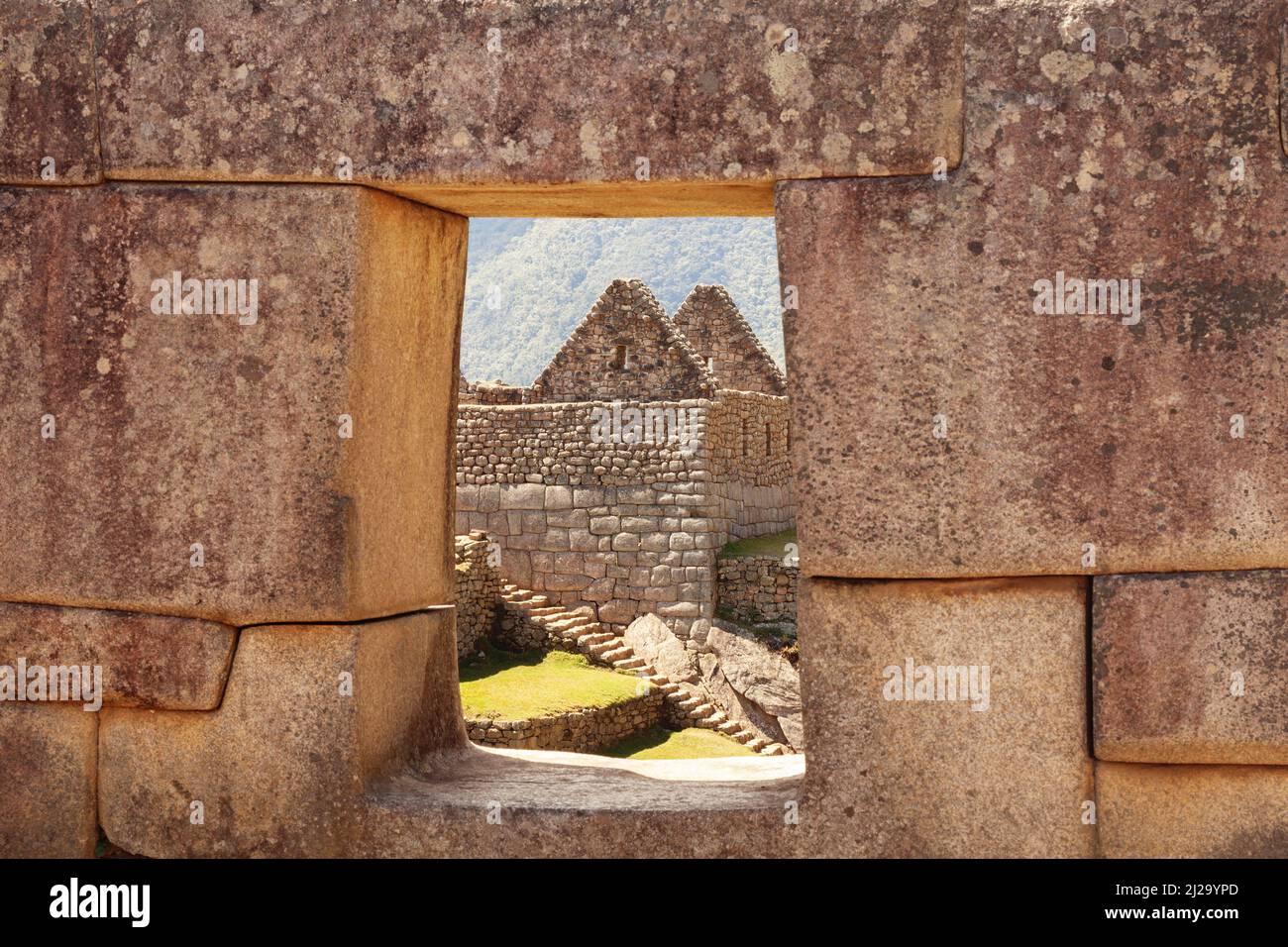A beautiful view through an old stone frame to old ancient pyramids in ...