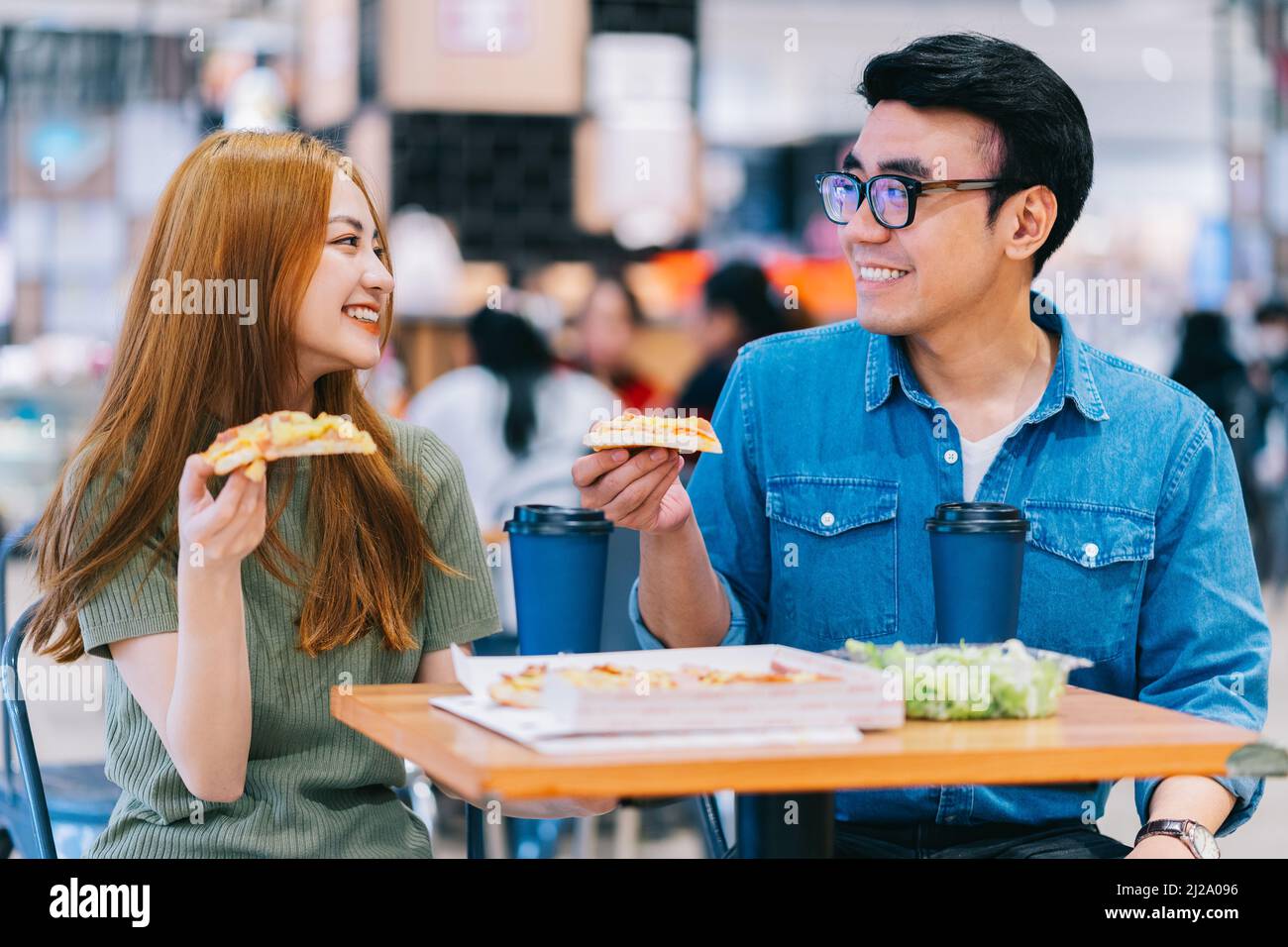 Young Asian couple having lunch together in cafe Stock Photo - Alamy