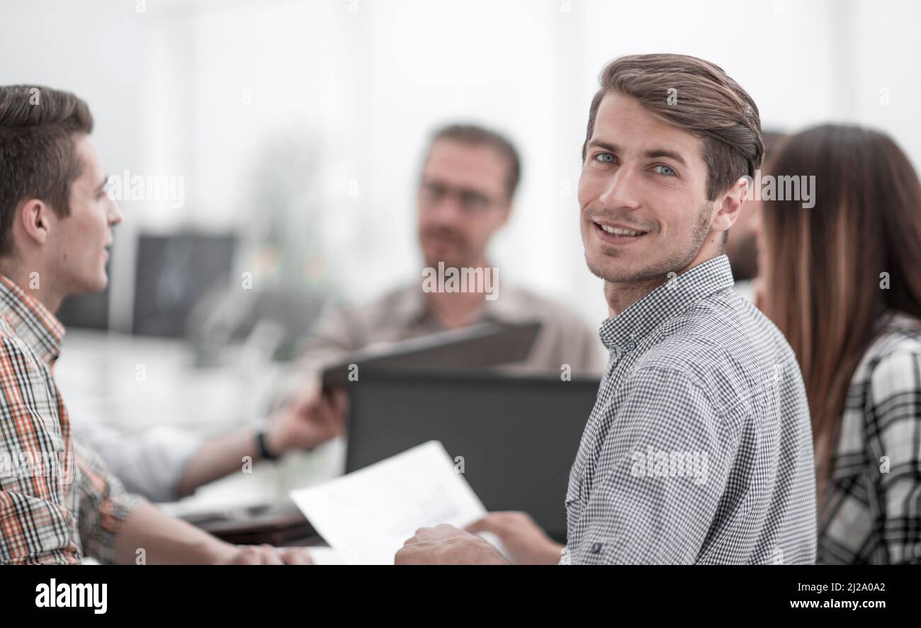 close up.successful employee sitting at the Desk Stock Photo - Alamy