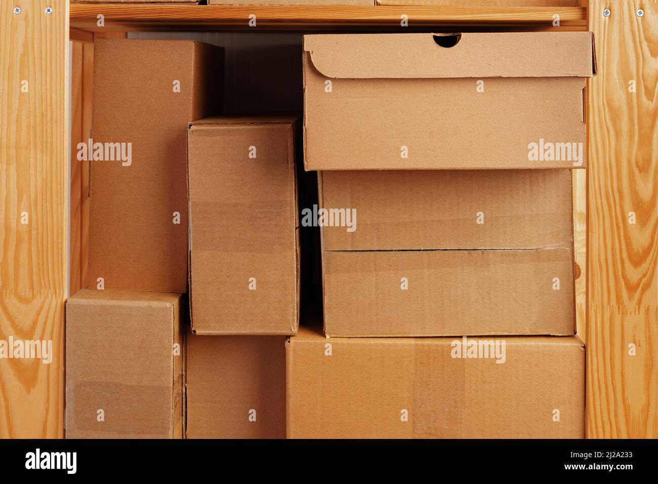 Stack of cardboard package boxes on wooden rack Stock Photo - Alamy