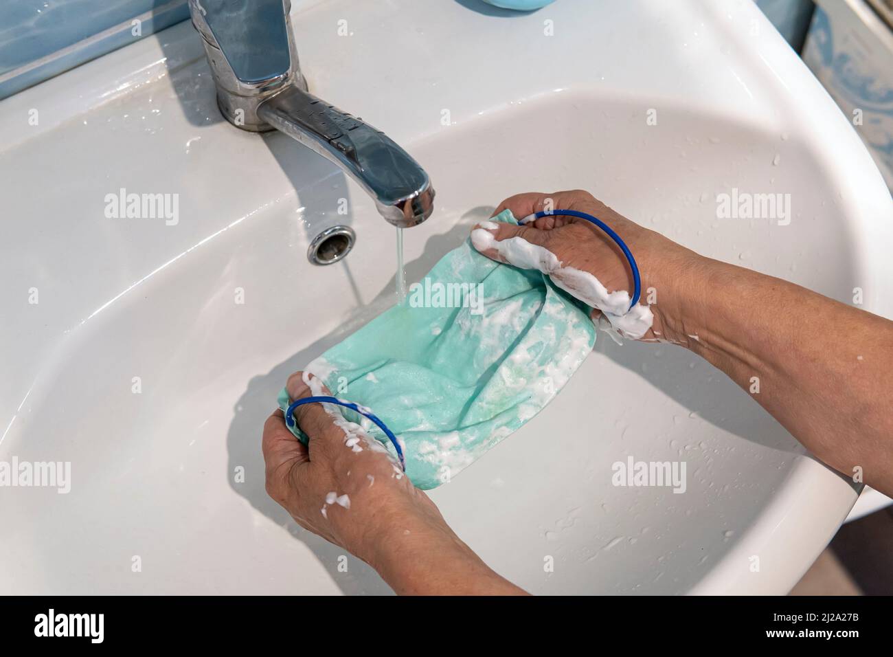 Washing cloth mask by hand after one use. Corona virus preventive face ...