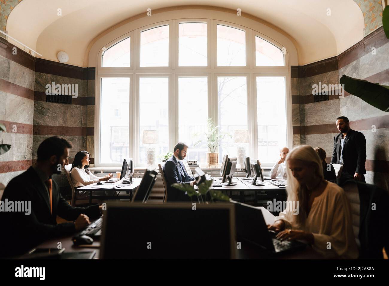 Female and male financial experts working together in office Stock ...
