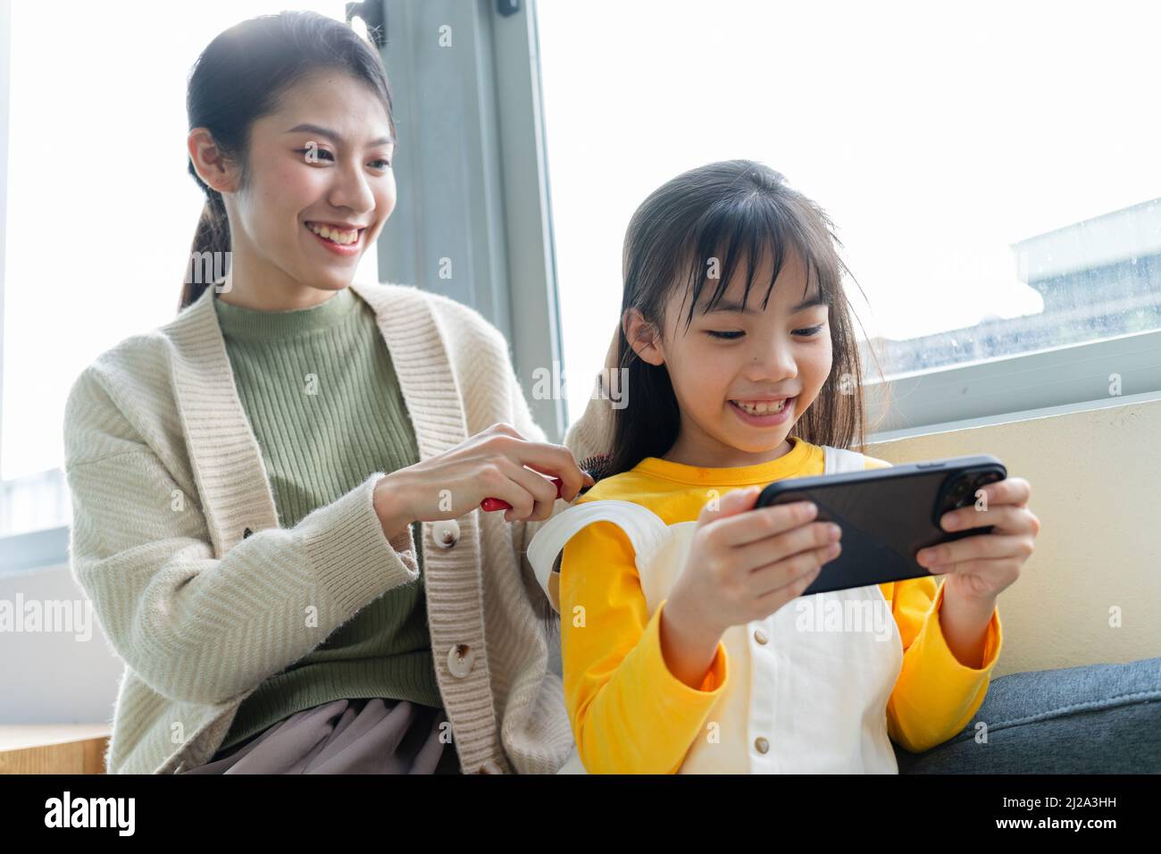 Asian mother and daughter at home together Stock Photo - Alamy