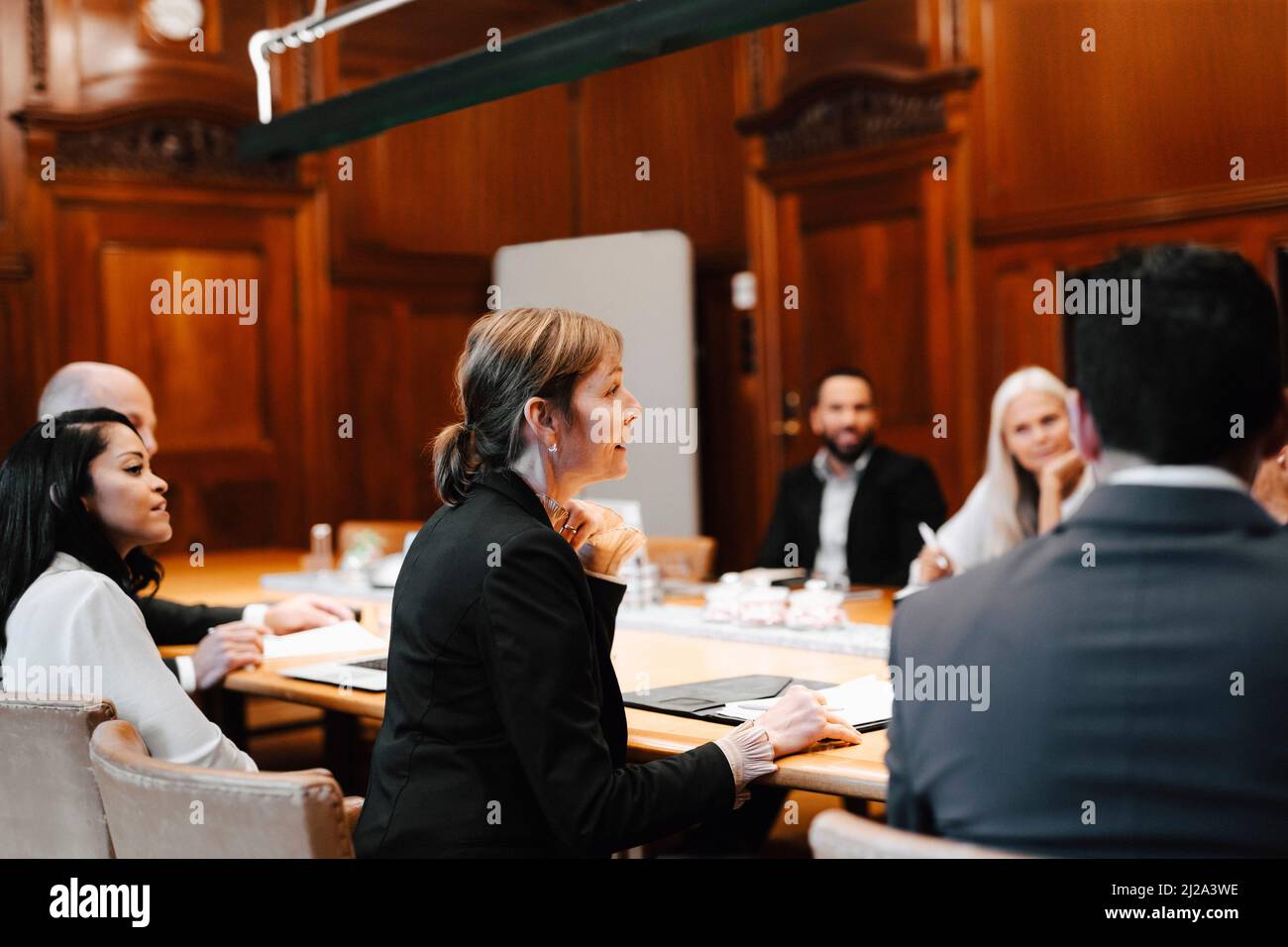 Team of law colleagues discussing in board room at office during ...