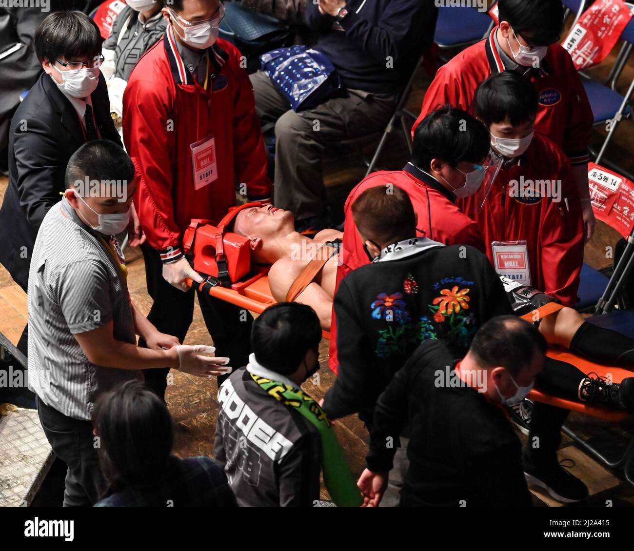 Yuichiro Kasuya is carried on a stretcher after losing the 8R 62kg ...