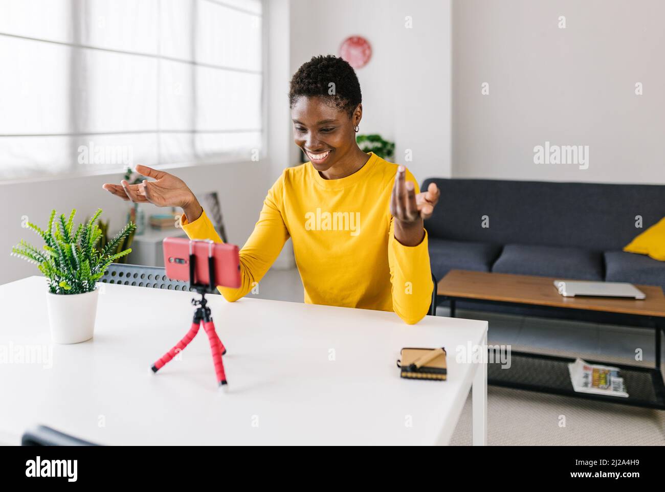 Young woman using a phone to record video to create social media ...