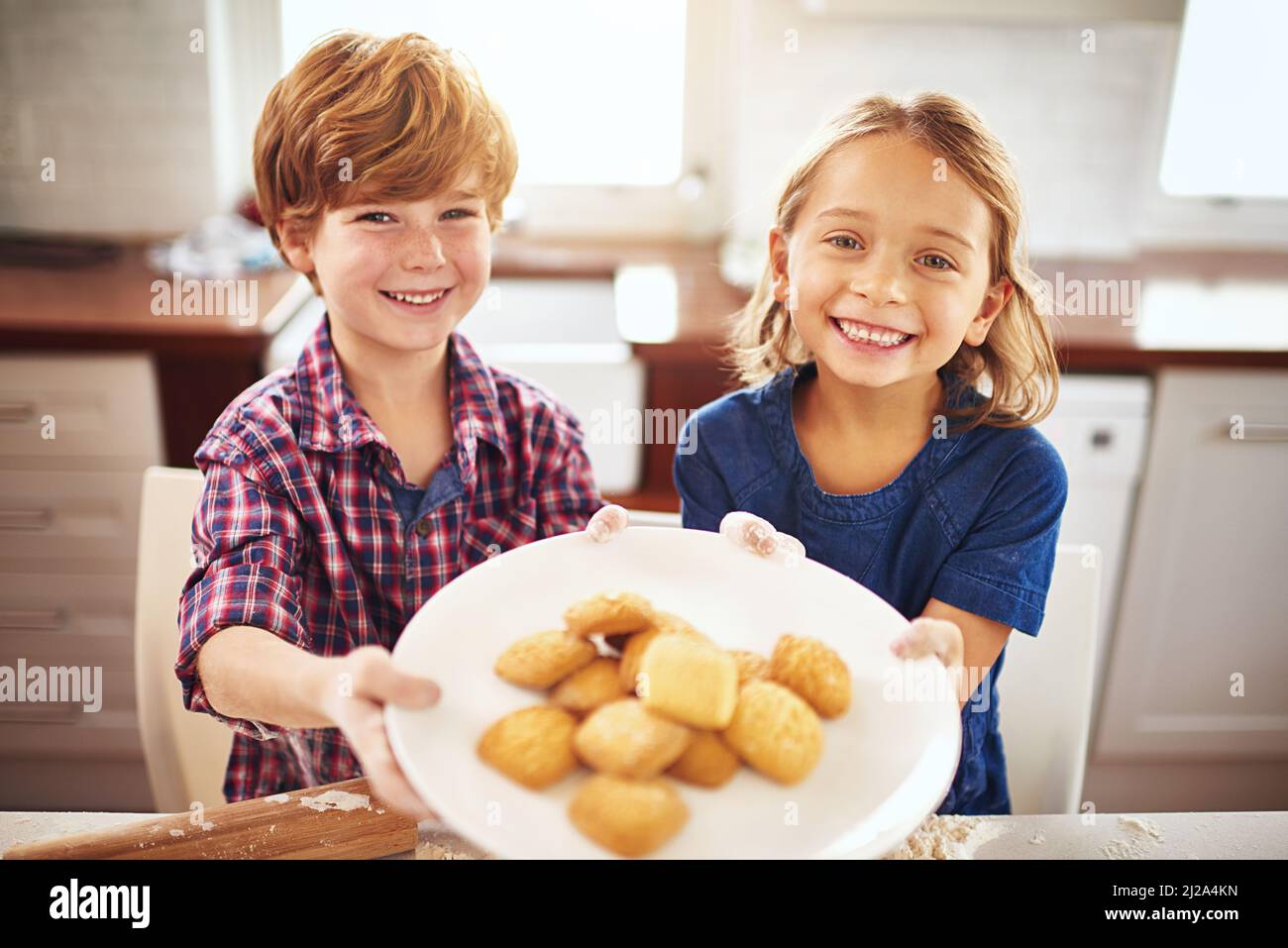 We present to you our delicious bakes. Portrait of two young children ...