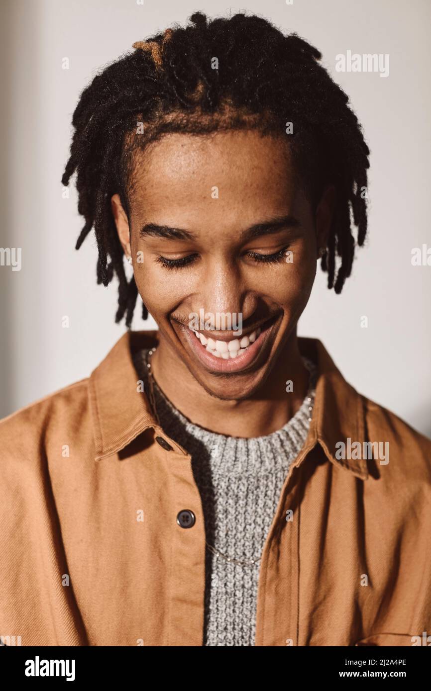 Happy young man looking down over white background Stock Photo - Alamy