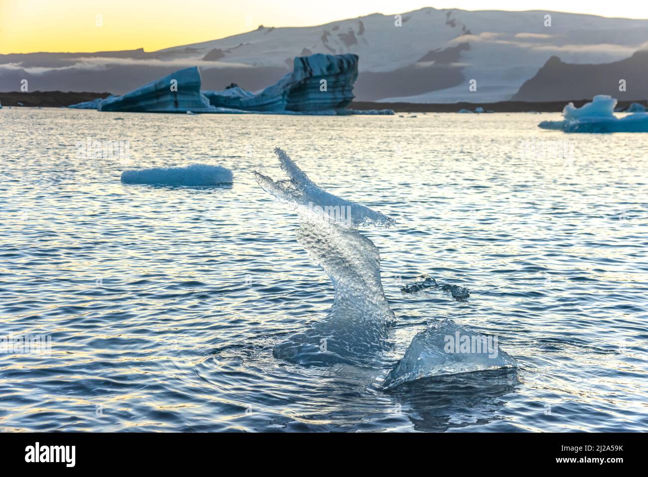Icebergs floating in Jokulsarlon glacier lagoon lake at sunset Stock ...