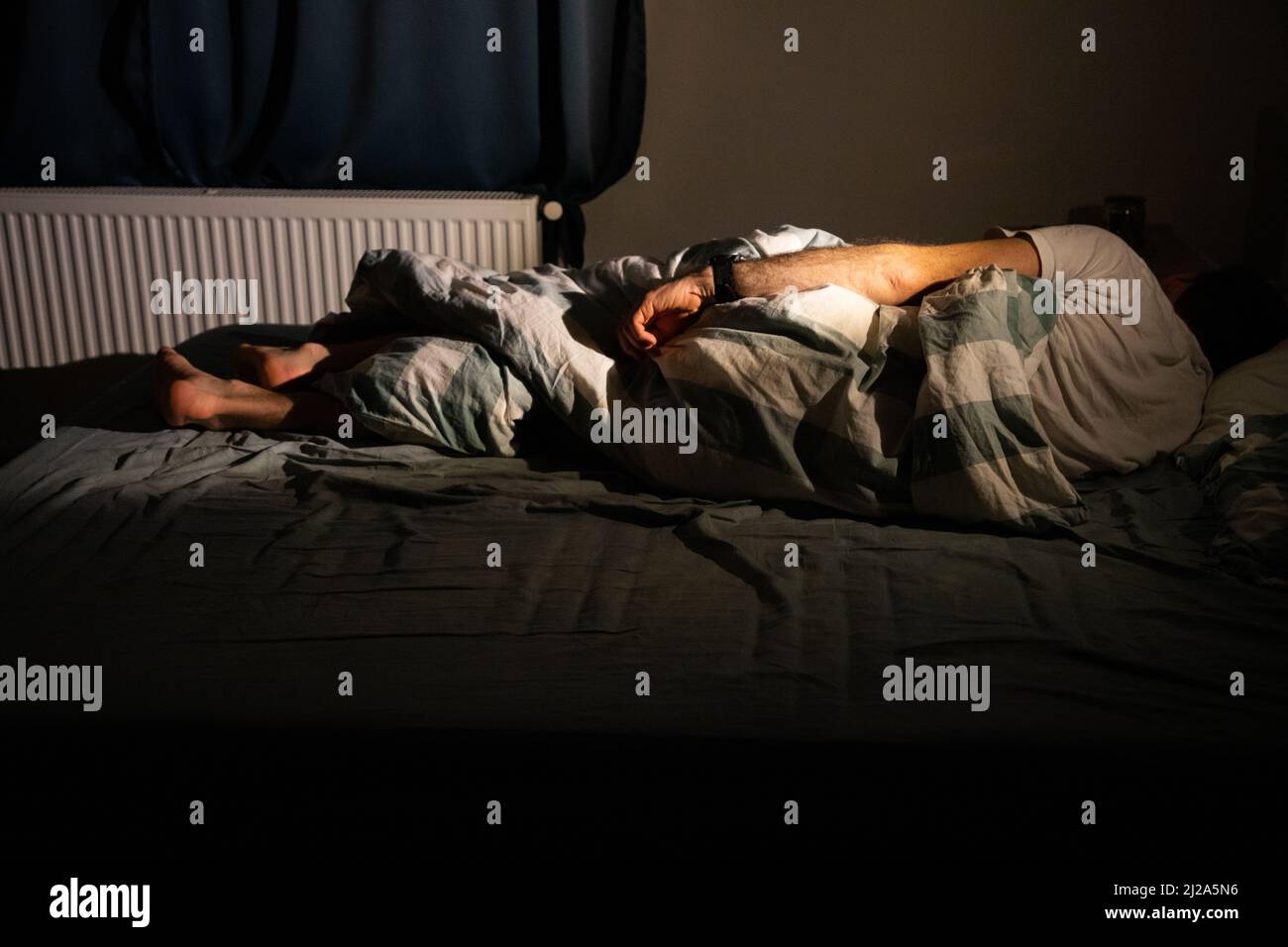 man sleeping in bed at night sleep quality insomnia Stock Photo - Alamy