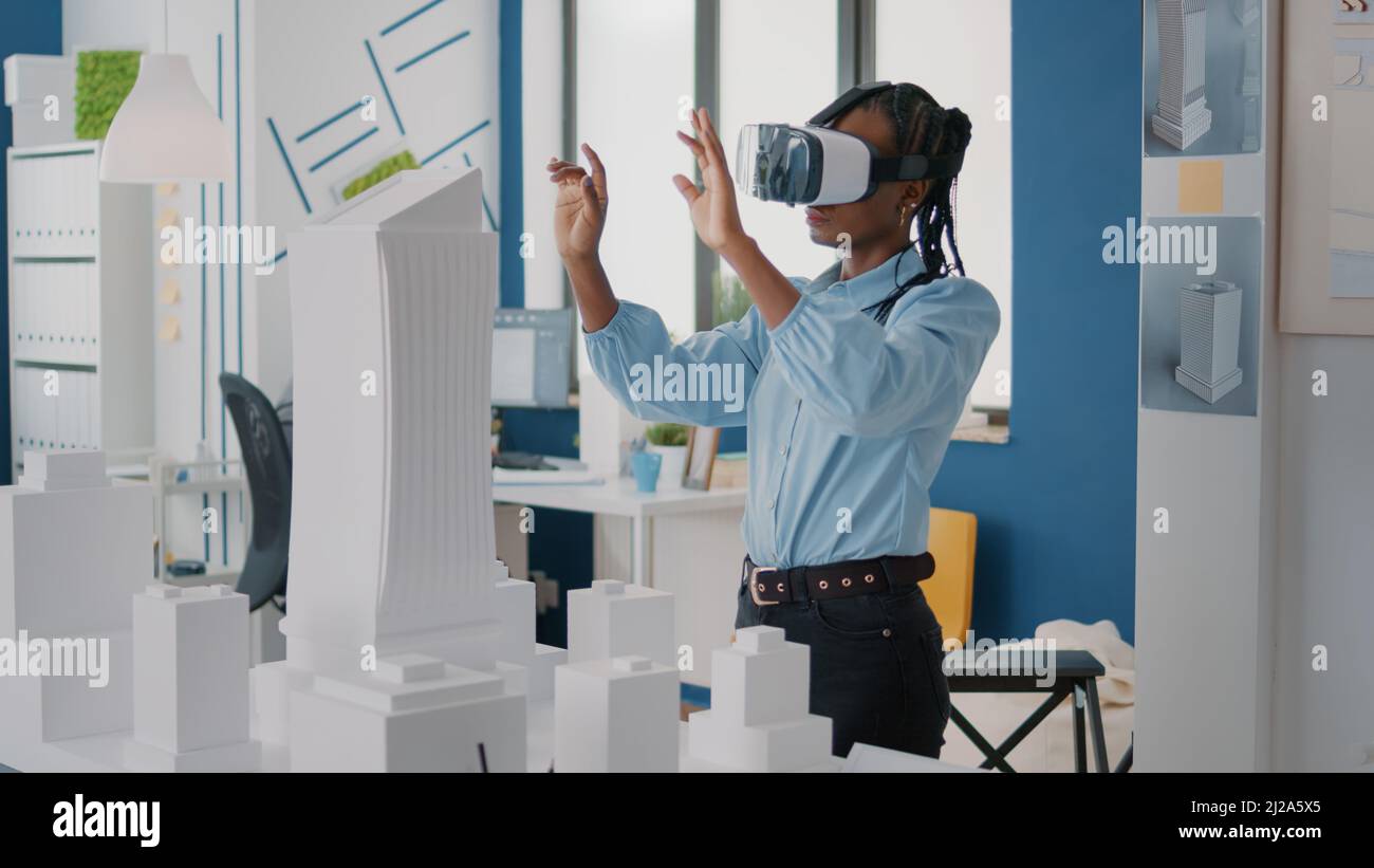 Woman architect wearing vr glasses to design construction layout and ...