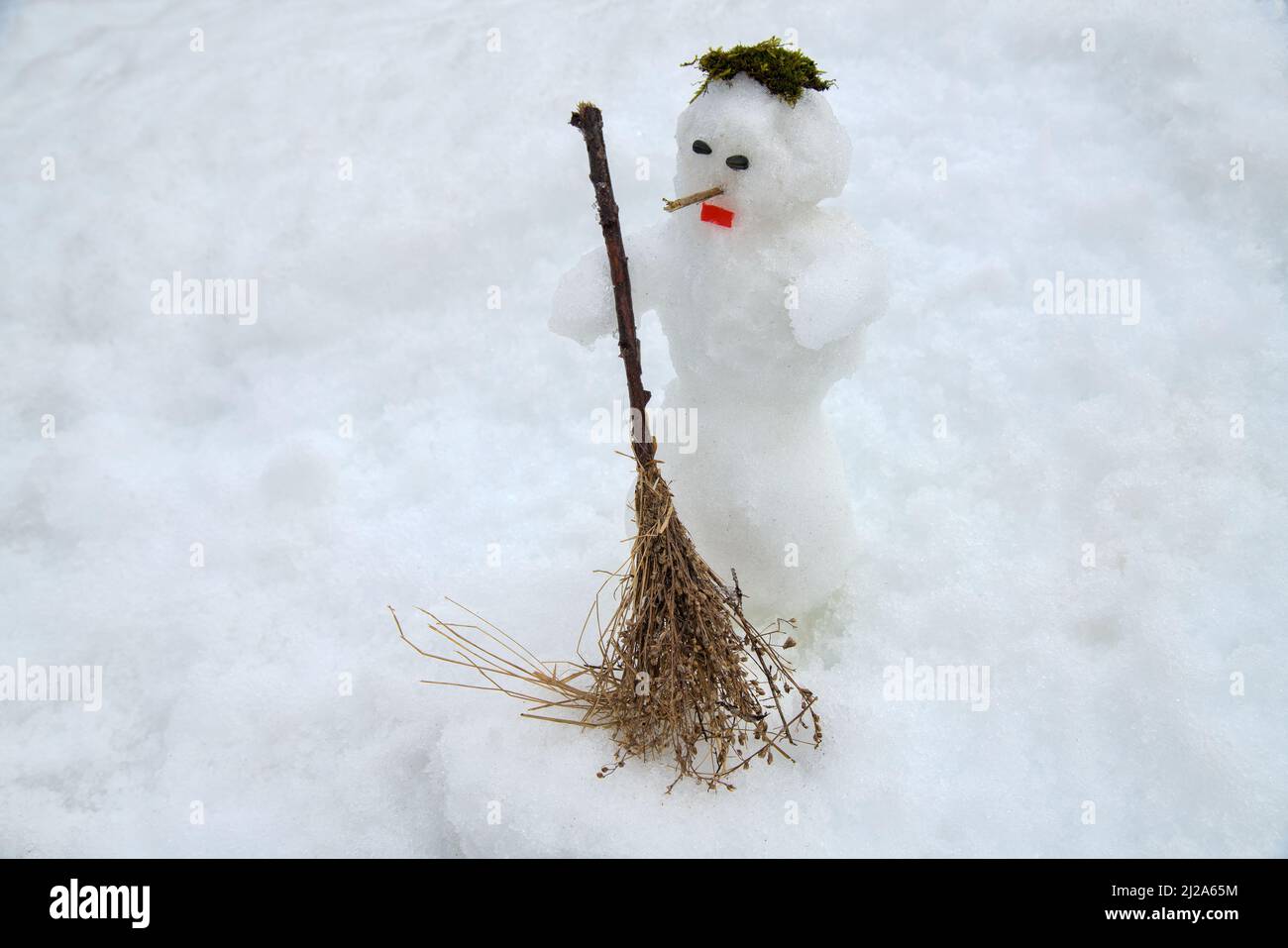 Snowman as snow cleaner and janitor Stock Photo - Alamy