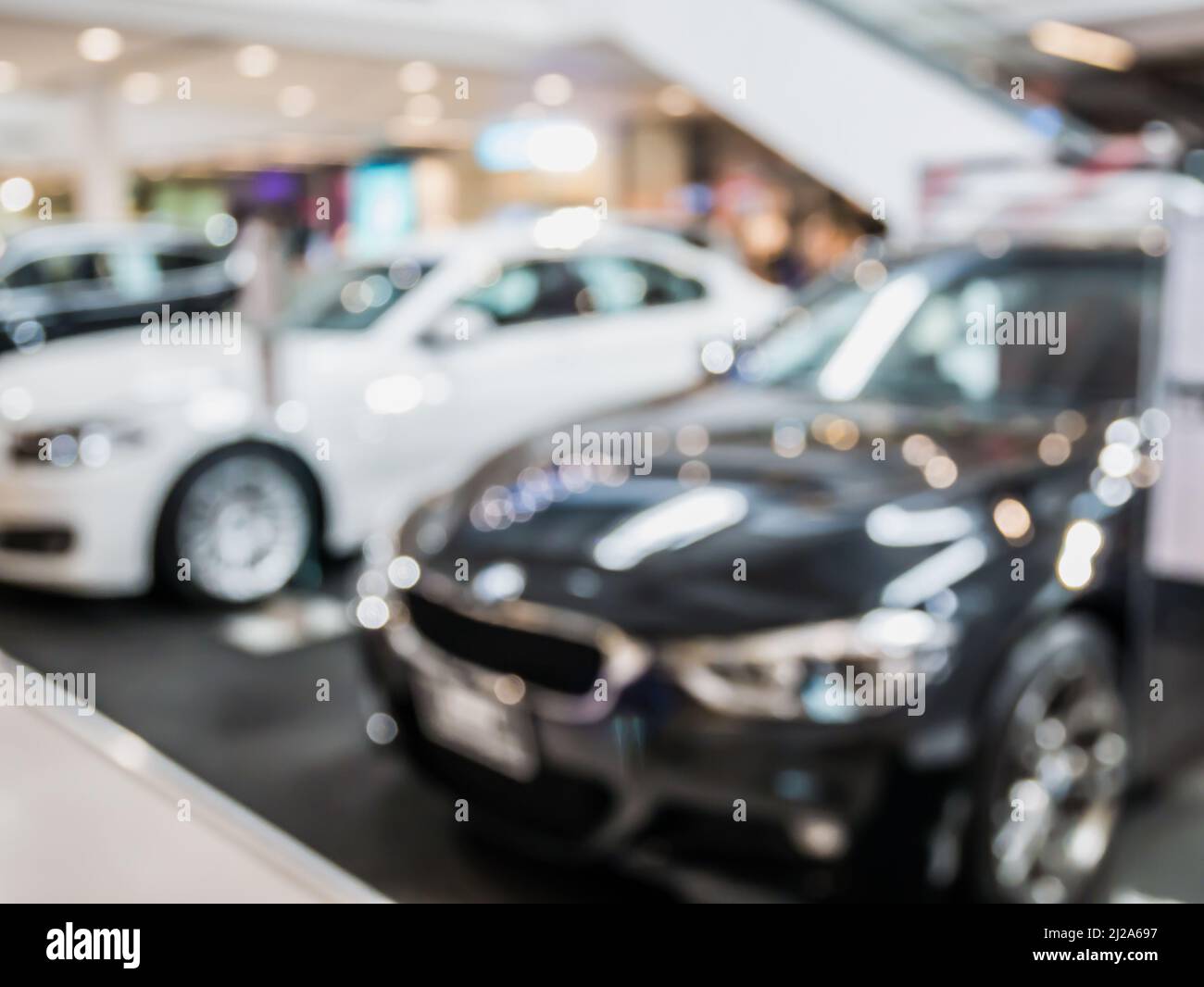 car showroom with new cars blur for background Stock Photo - Alamy