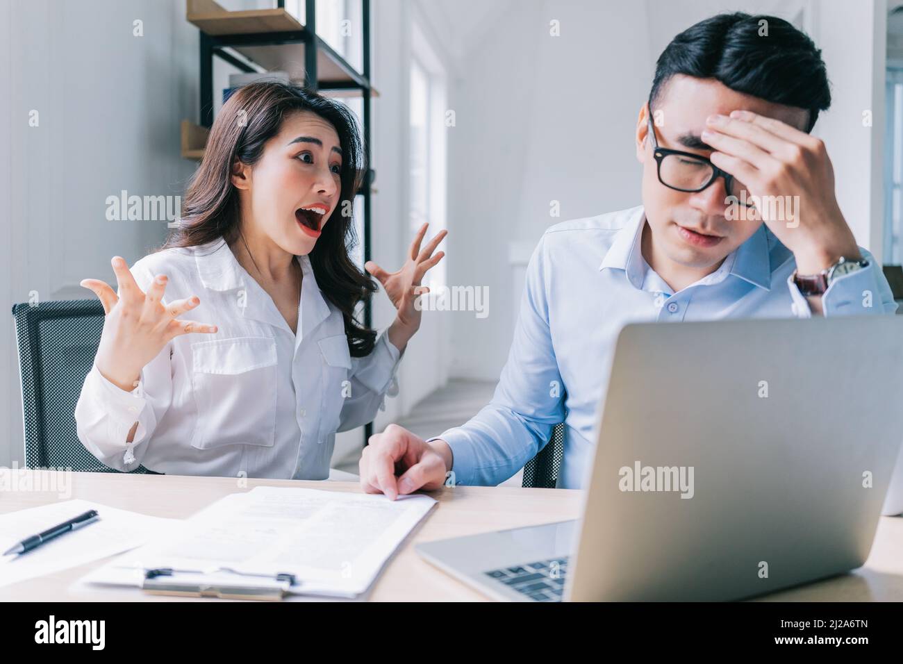 Two Asian colleagues are having a heated argument with each other Stock ...