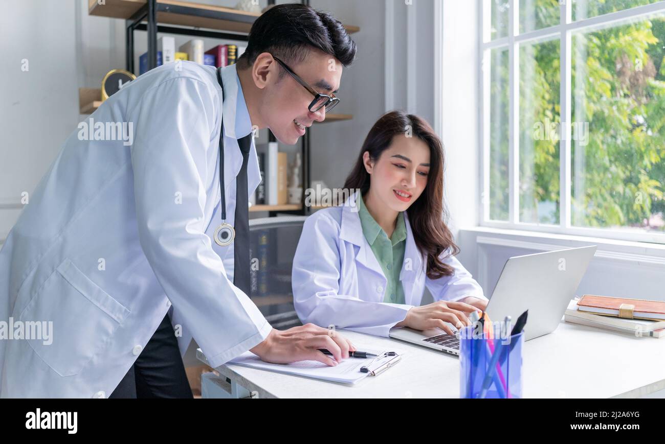 Two Asian doctors working together Stock Photo - Alamy
