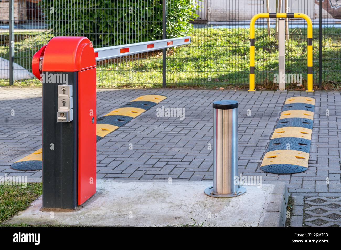 Electric barrier and speed bumps at the entrance to a parking lot Stock ...